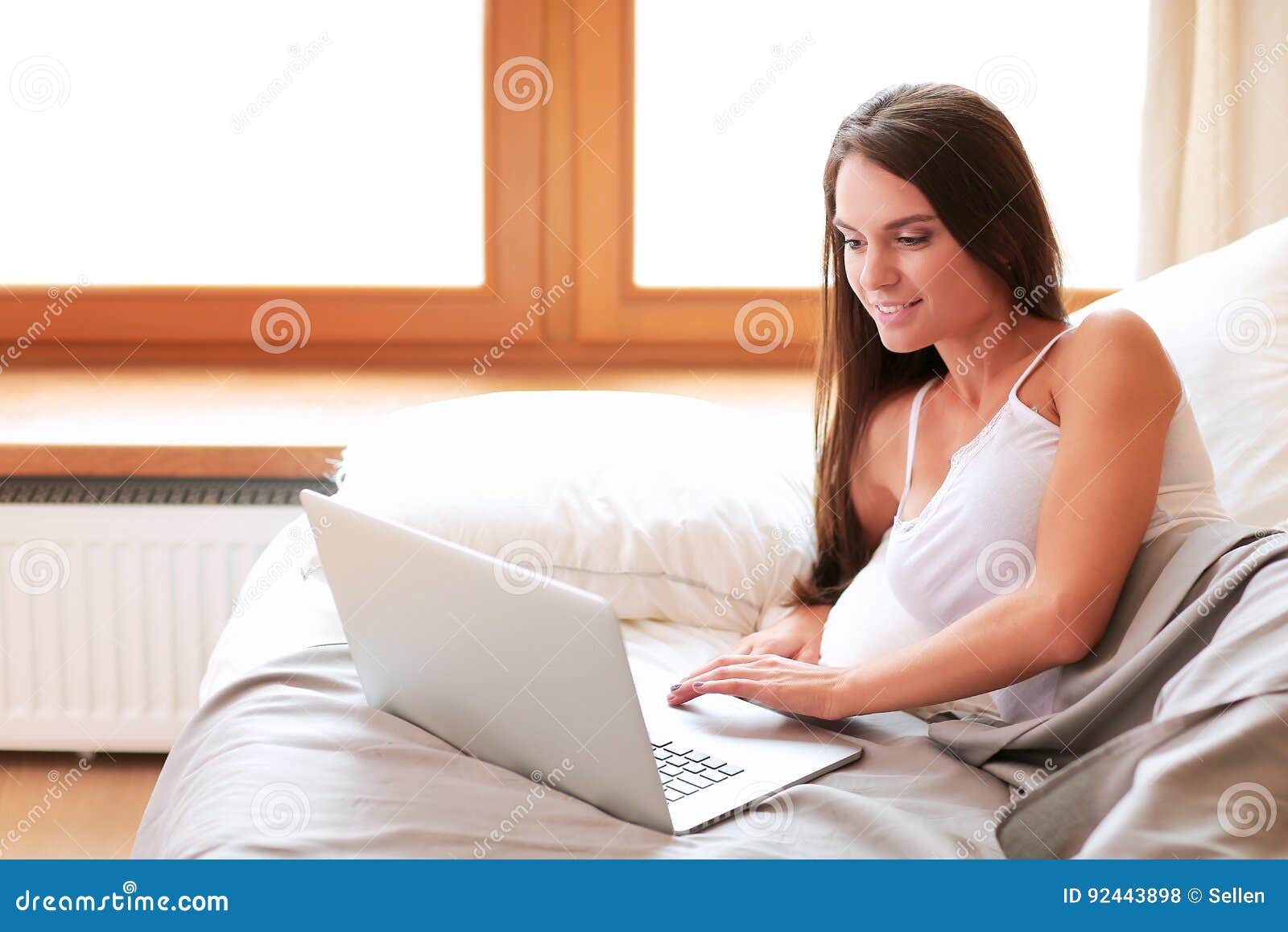 Young Woman Using Laptop in Bed at Home Stock Photo - Image of indoors ...