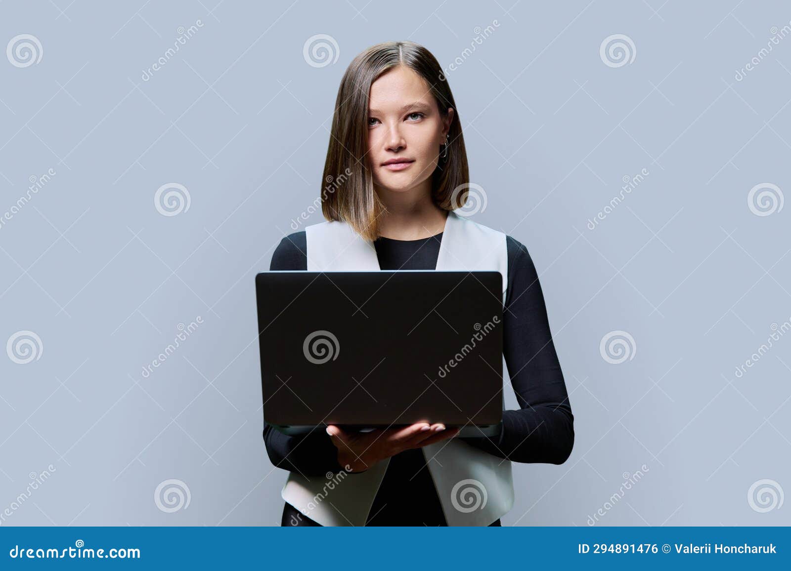 Young Woman Using Laptop Computer, on Grey Background Stock Photo ...
