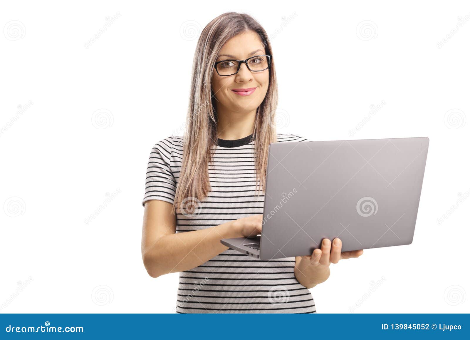 Young Woman Using a Laptop Computer and Smiling at the Camera Stock ...