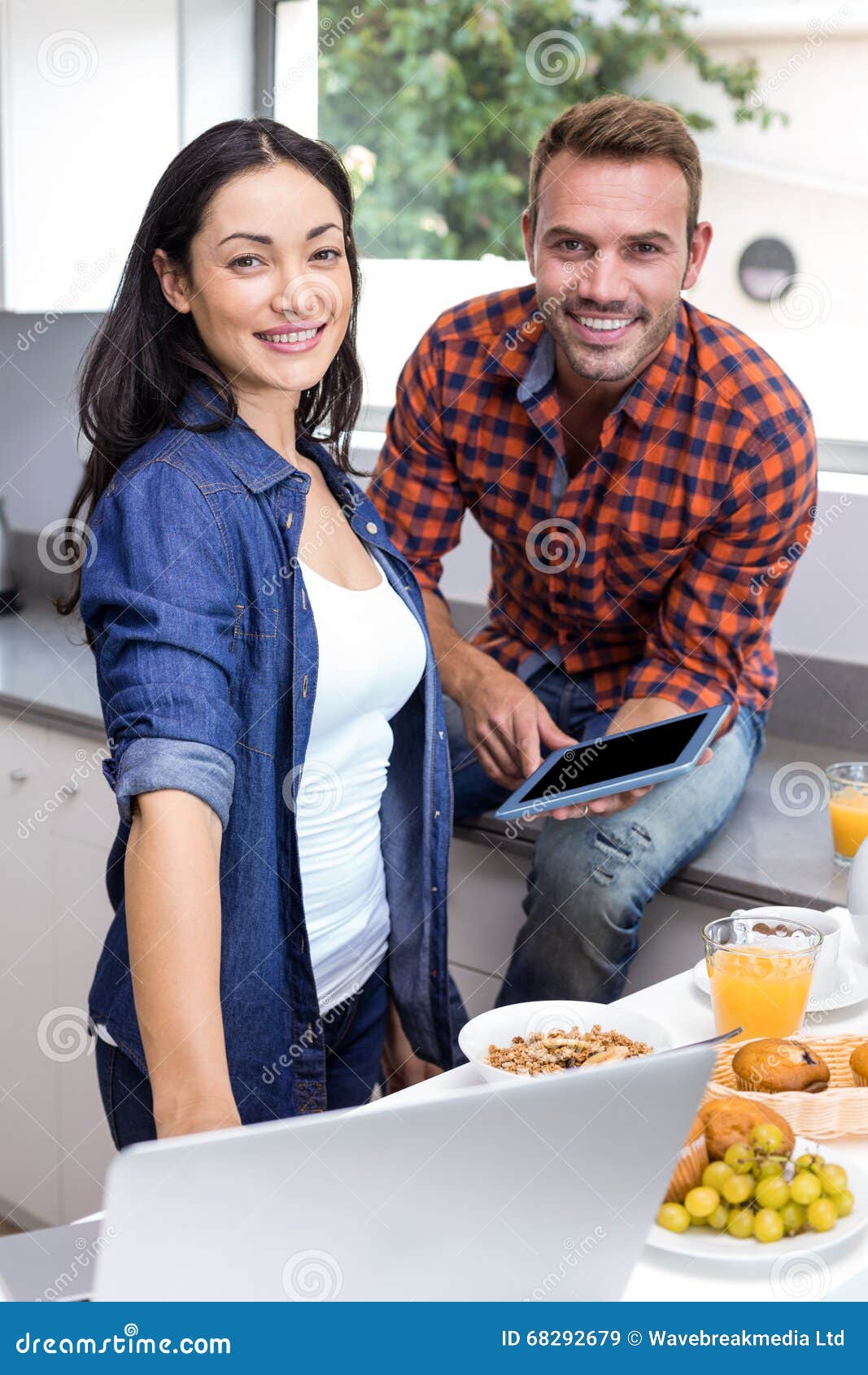 Young Woman Using Laptop and Man Using Digital Tablet Stock Image ...