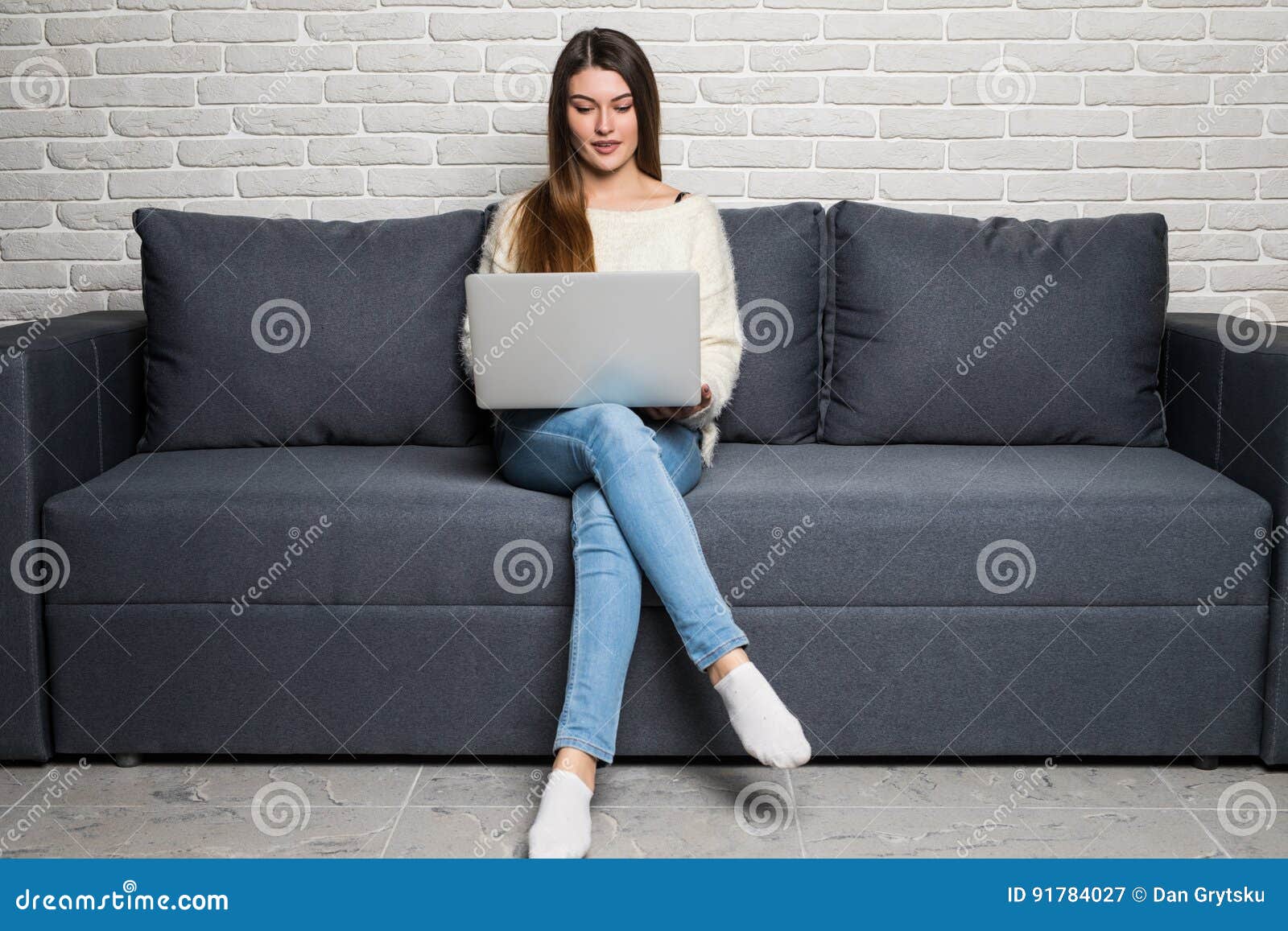 Young Woman Using Laptop while Sitting on Comfortable Sofa Stock Image ...