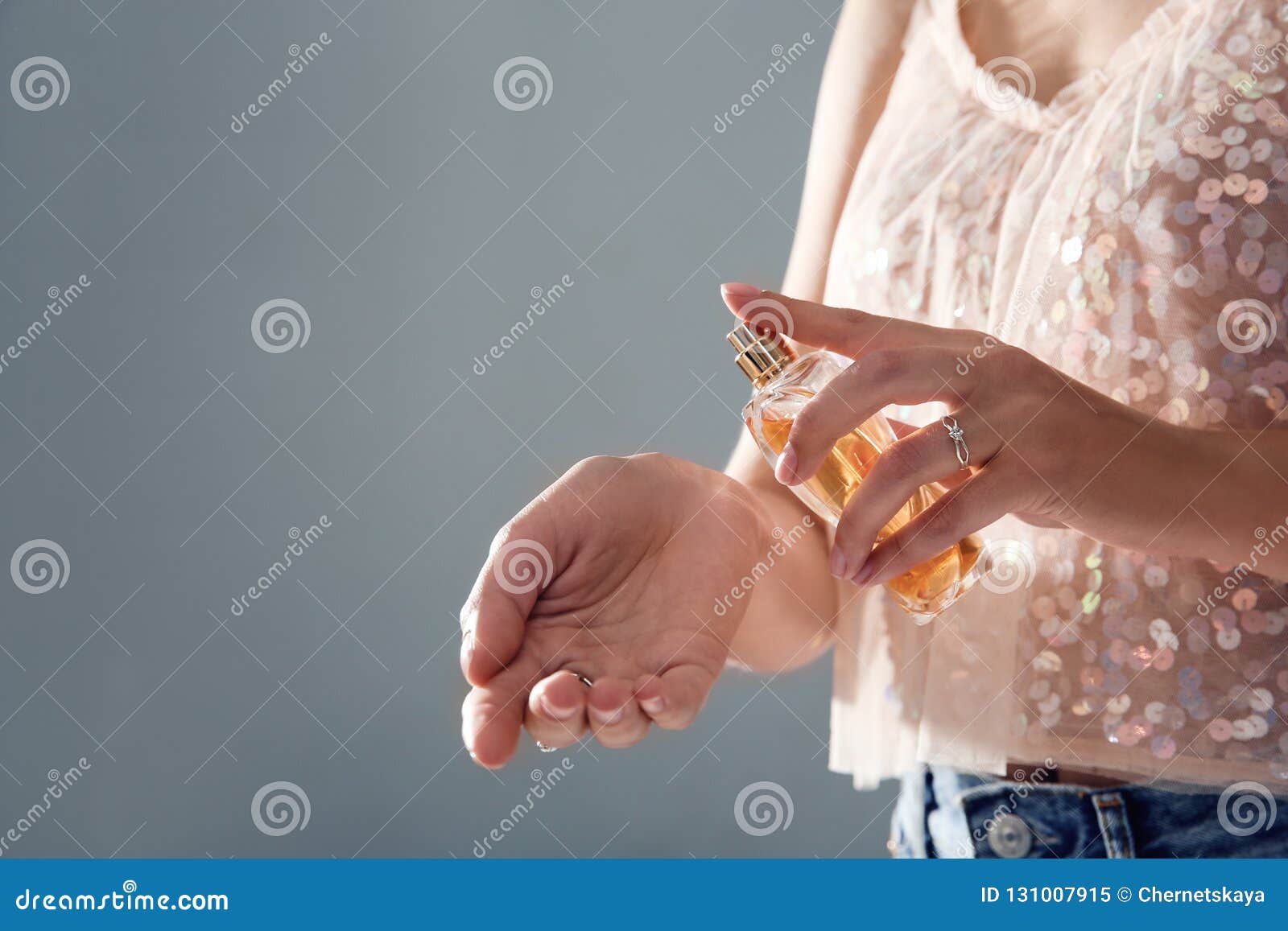 Young woman using perfume stock image. Image of female - 131007915