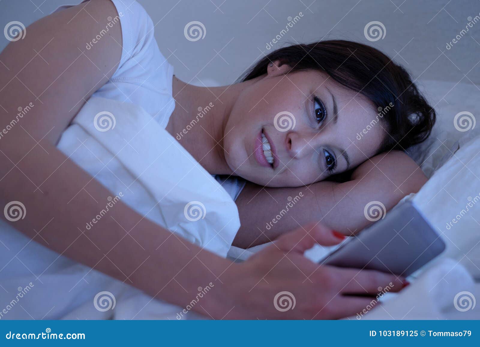 Young Woman Using Phone Lying in Bed Stock Image - Image of indoors ...