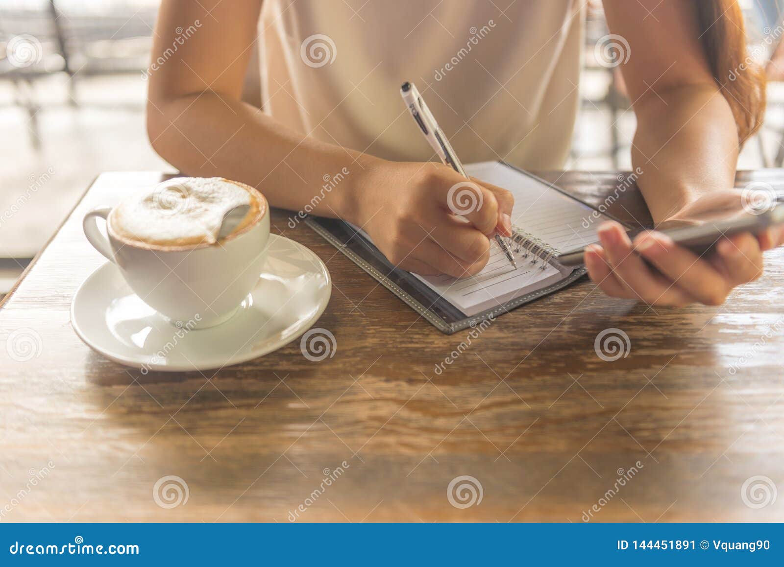 Young Woman Using Phone and Writing Notes Stock Image - Image of ...