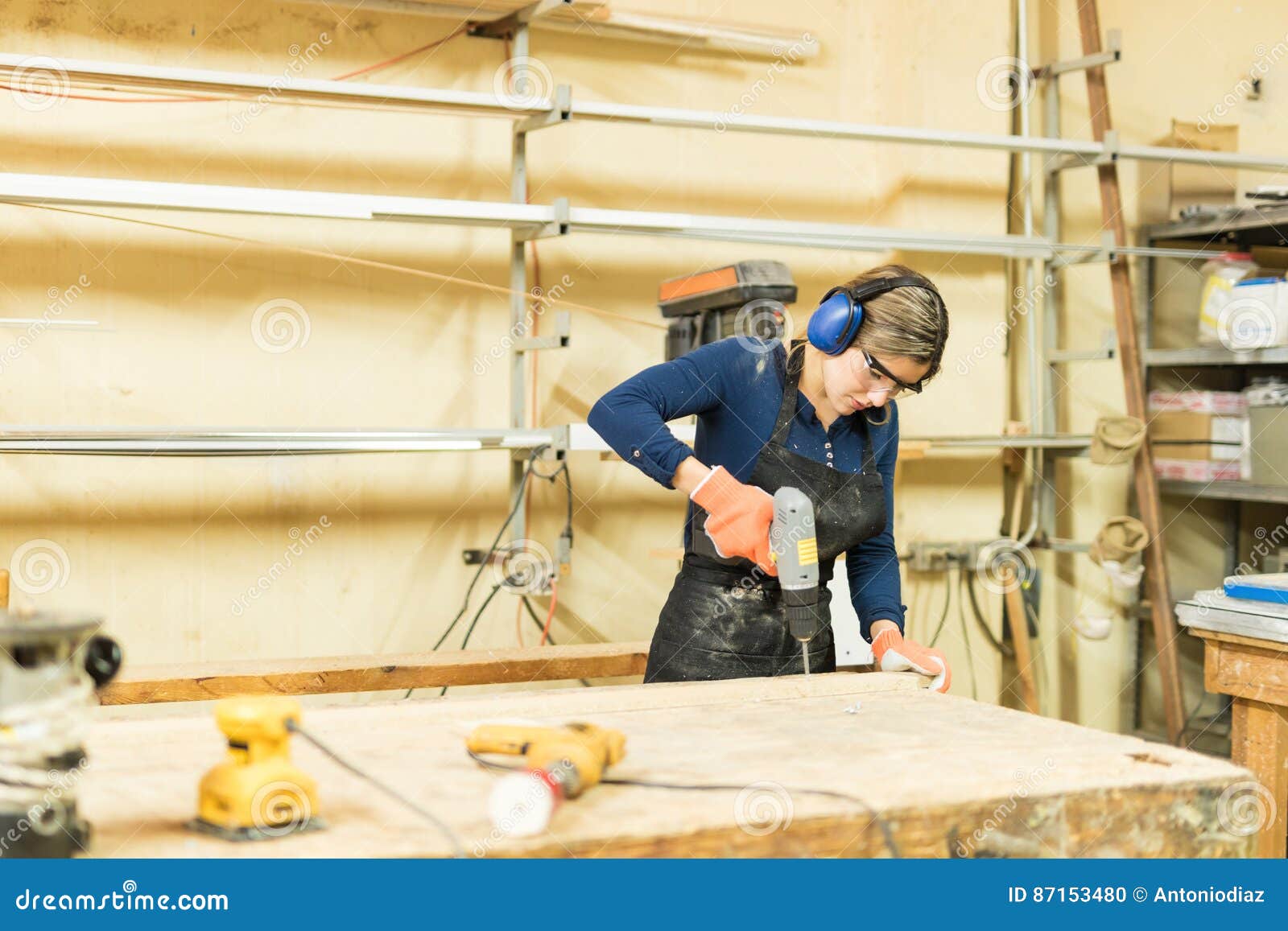 Young Woman Using a Screwdriver at Work Stock Photo - Image of ...