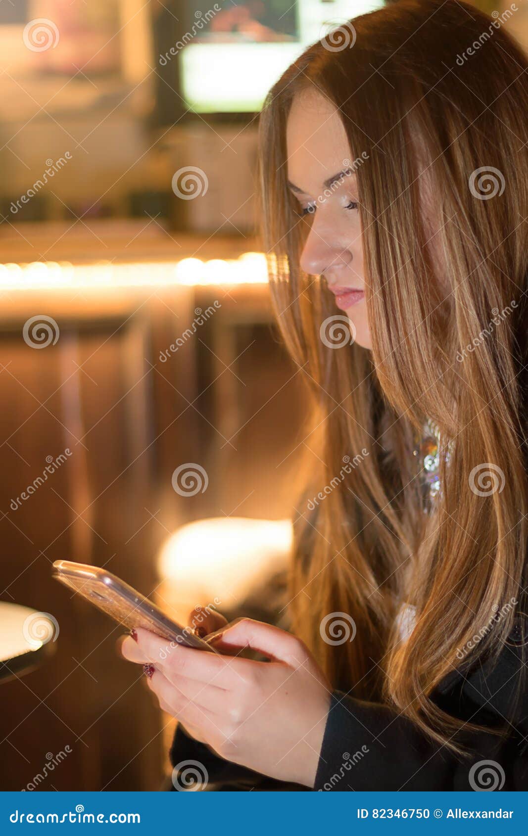 Young Woman Using a Smart Phone in a Nightclub Stock Photo - Image of ...