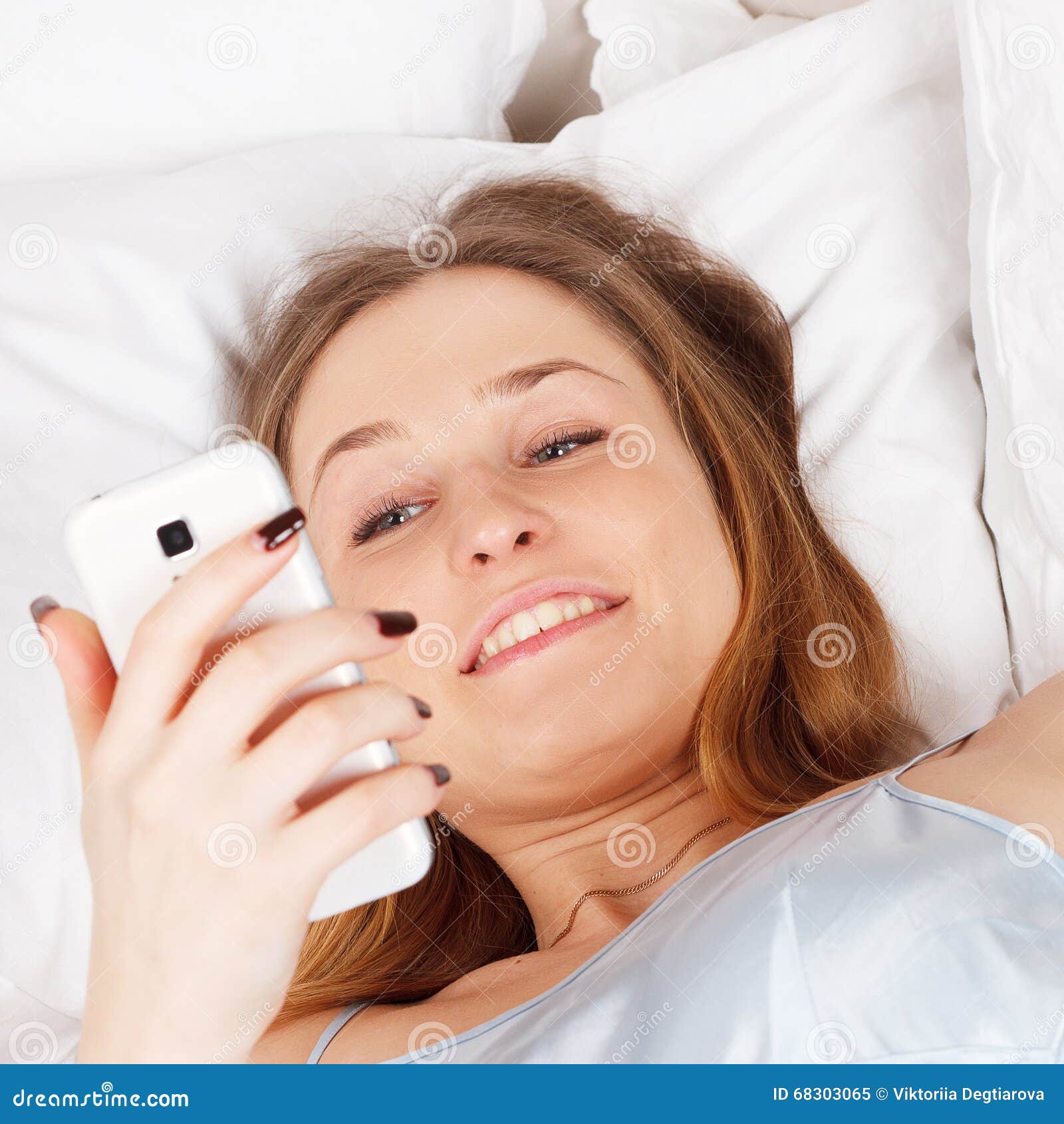 Young Woman Using Smartphone on the Bed Stock Image - Image of bedroom ...