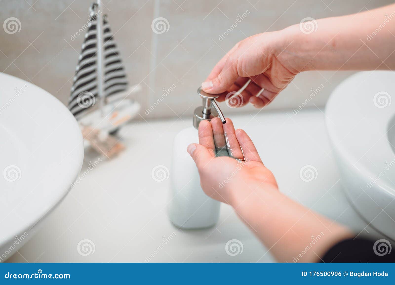 Young Woman Using Soap Dispenser and Washing Hands at Home Stock Photo ...