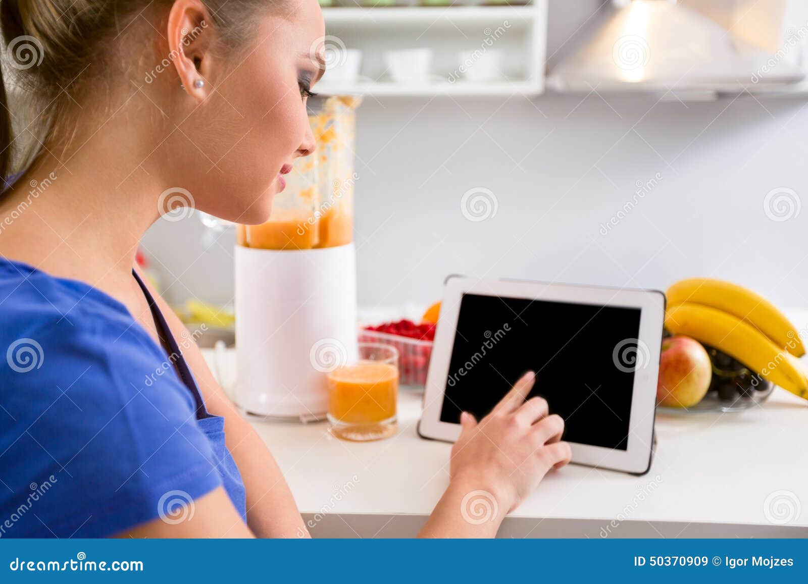 Young Woman Using Tablet in Kitchen Stock Image - Image of horizontal ...