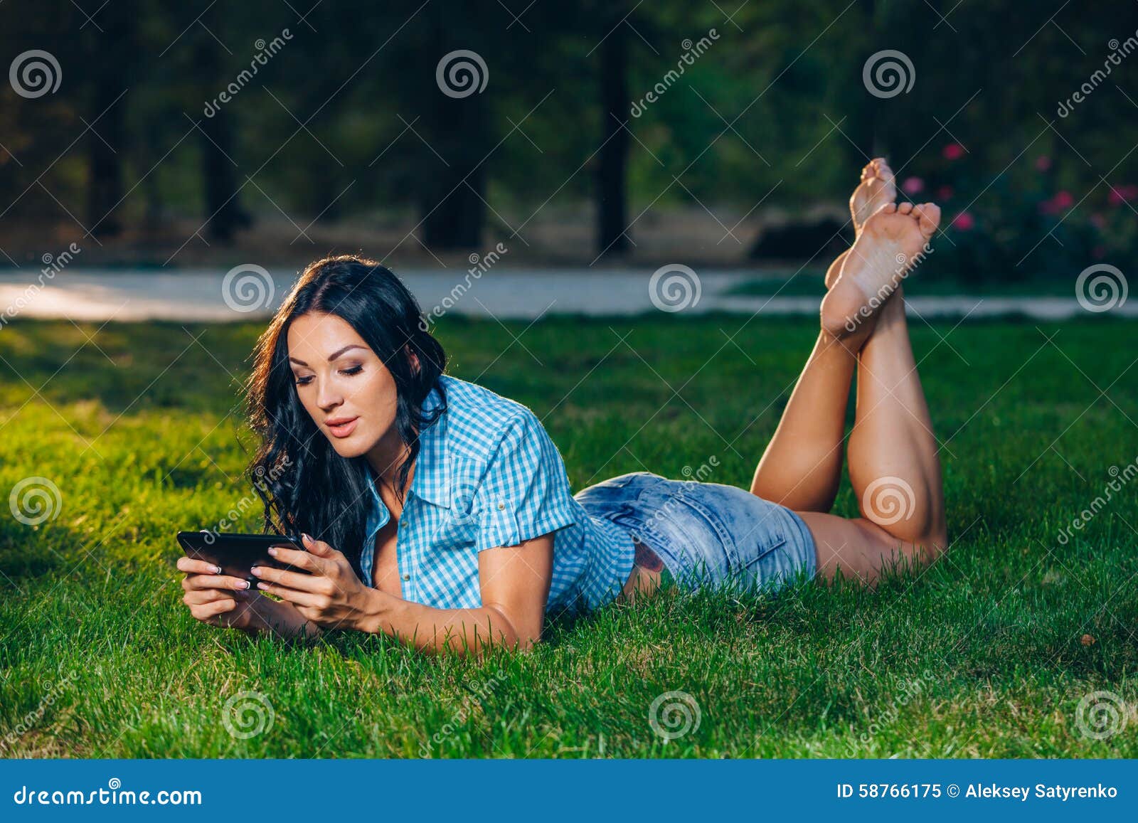 Young Woman Using Tablet Outdoor Laying on Grass Stock Image - Image of ...