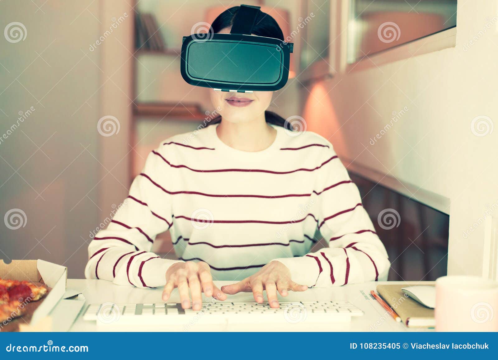 Young Woman Using VR Headset while Working on Computer Stock Image ...