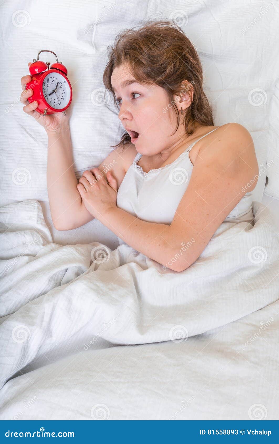 Young Woman is Waking Up and Looking at Clock. she Oversleep and is ...