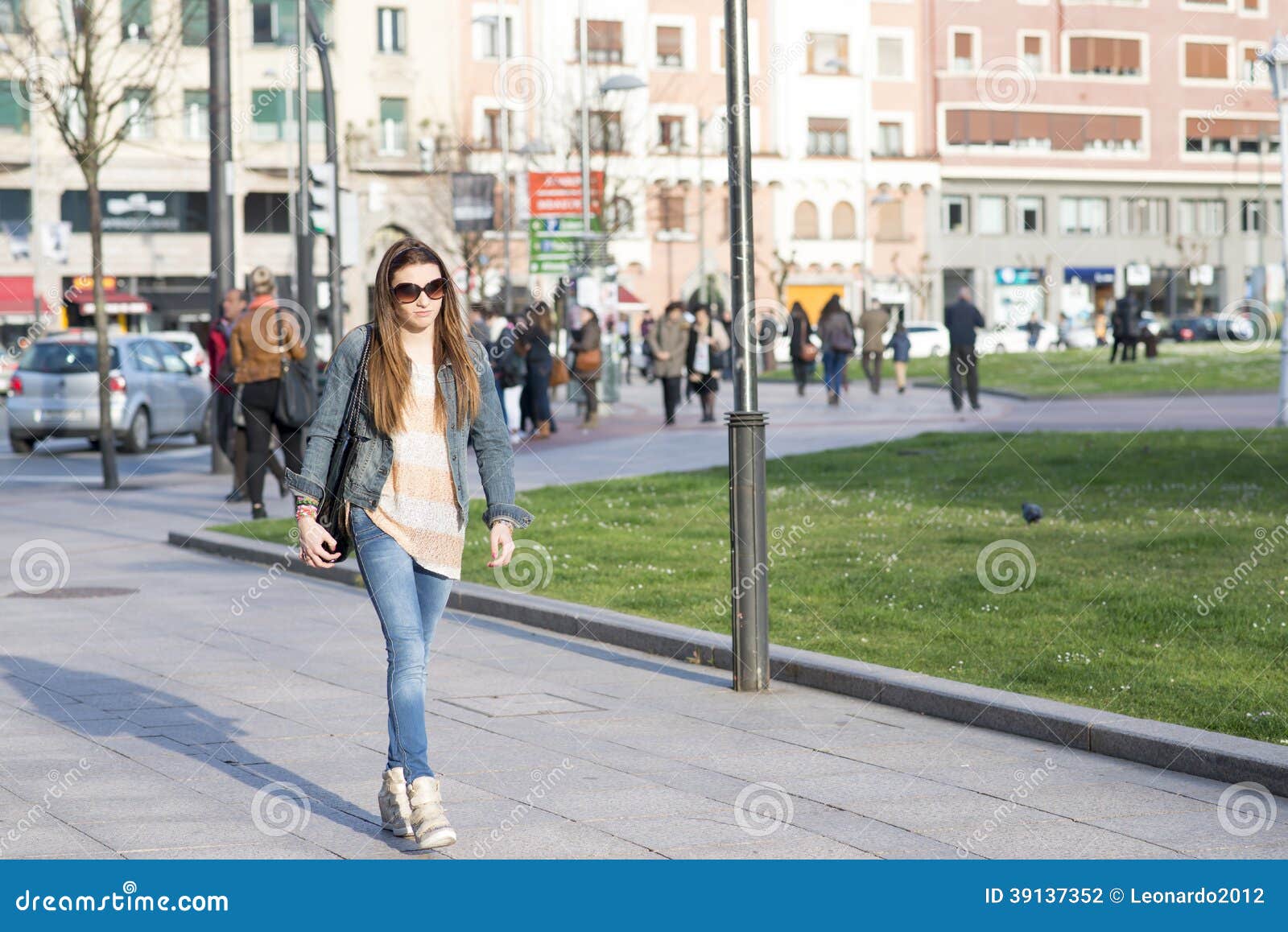 Young Woman Walking through the Crowd on the Street. Stock Photo ...