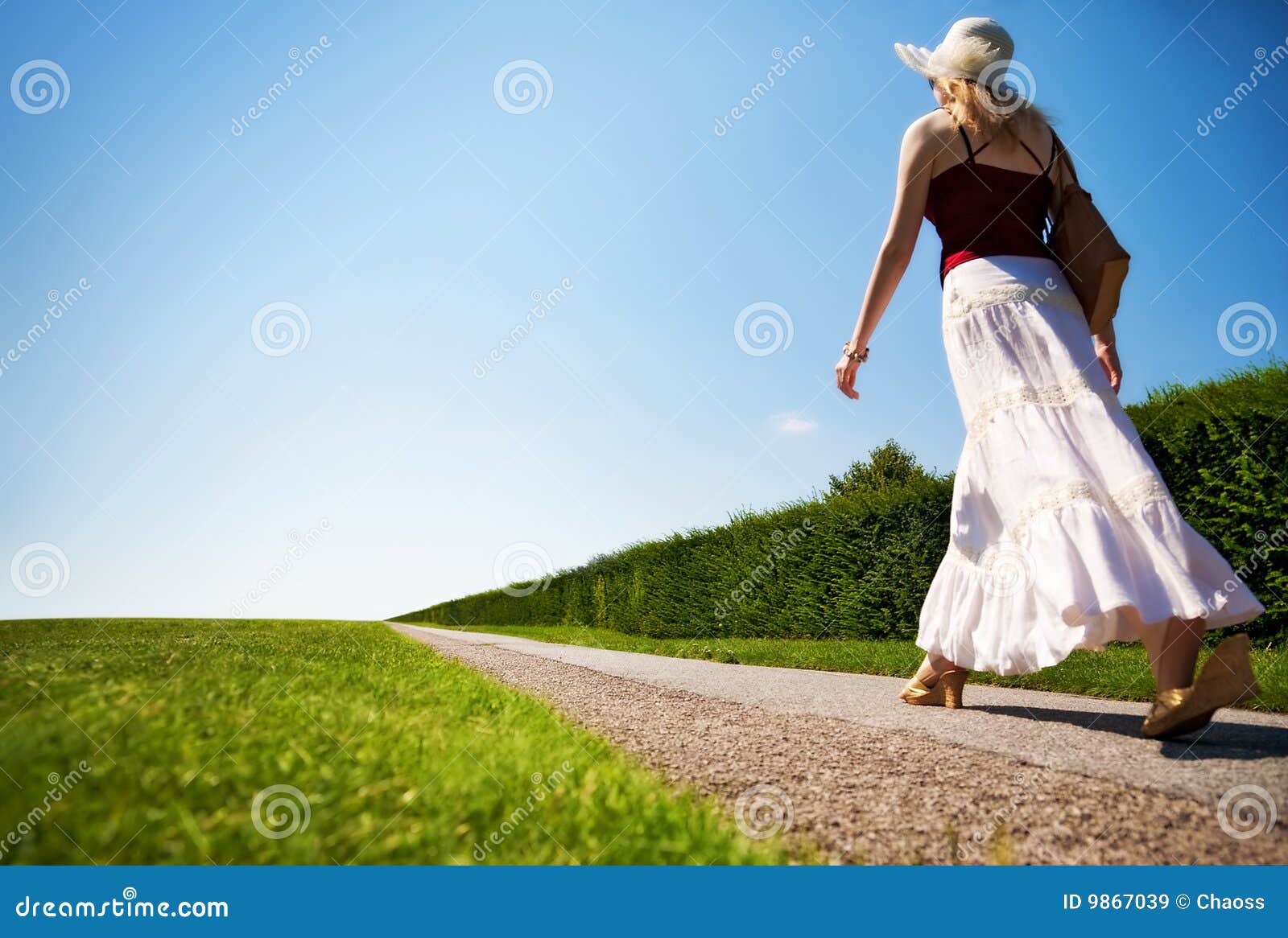 Young Woman Walking Fast on a Road Stock Image - Image of dress, angle ...