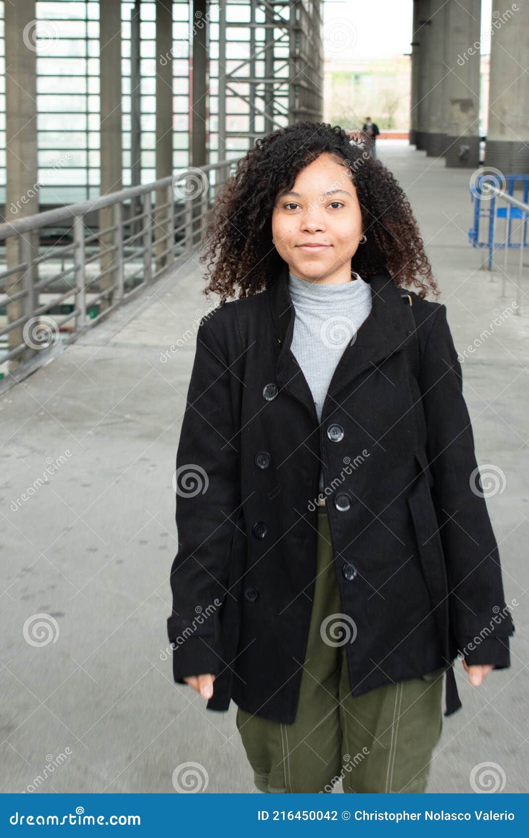 Young Woman Walking Forward and Looking at the Camera Stock Photo ...