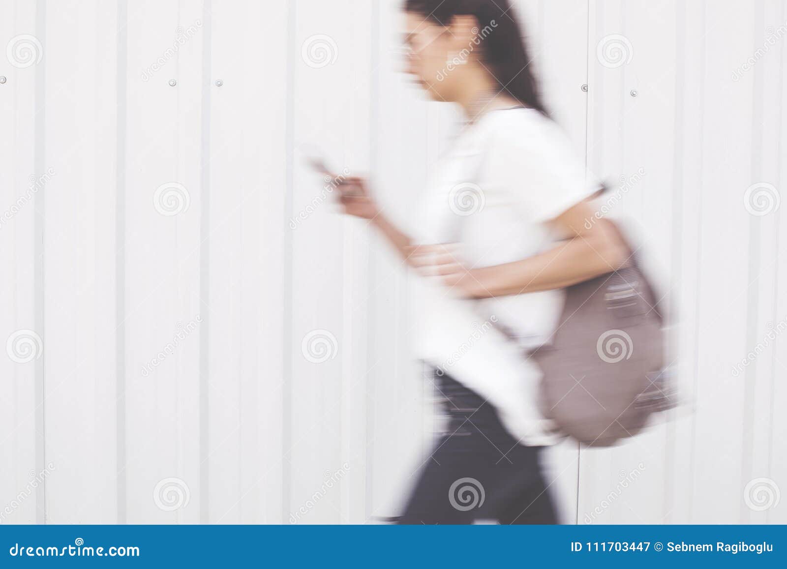 Young Woman Walking and Using Mobile Phone Outside Stock Image - Image ...