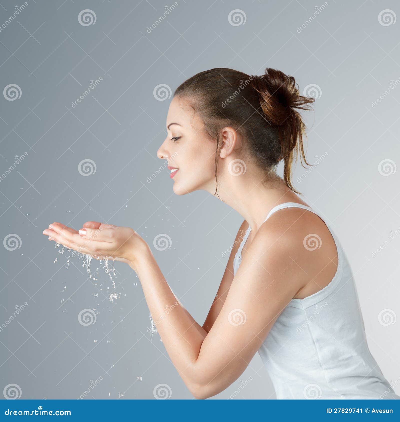 Young woman washing face stock image. Image of brunette - 27829741