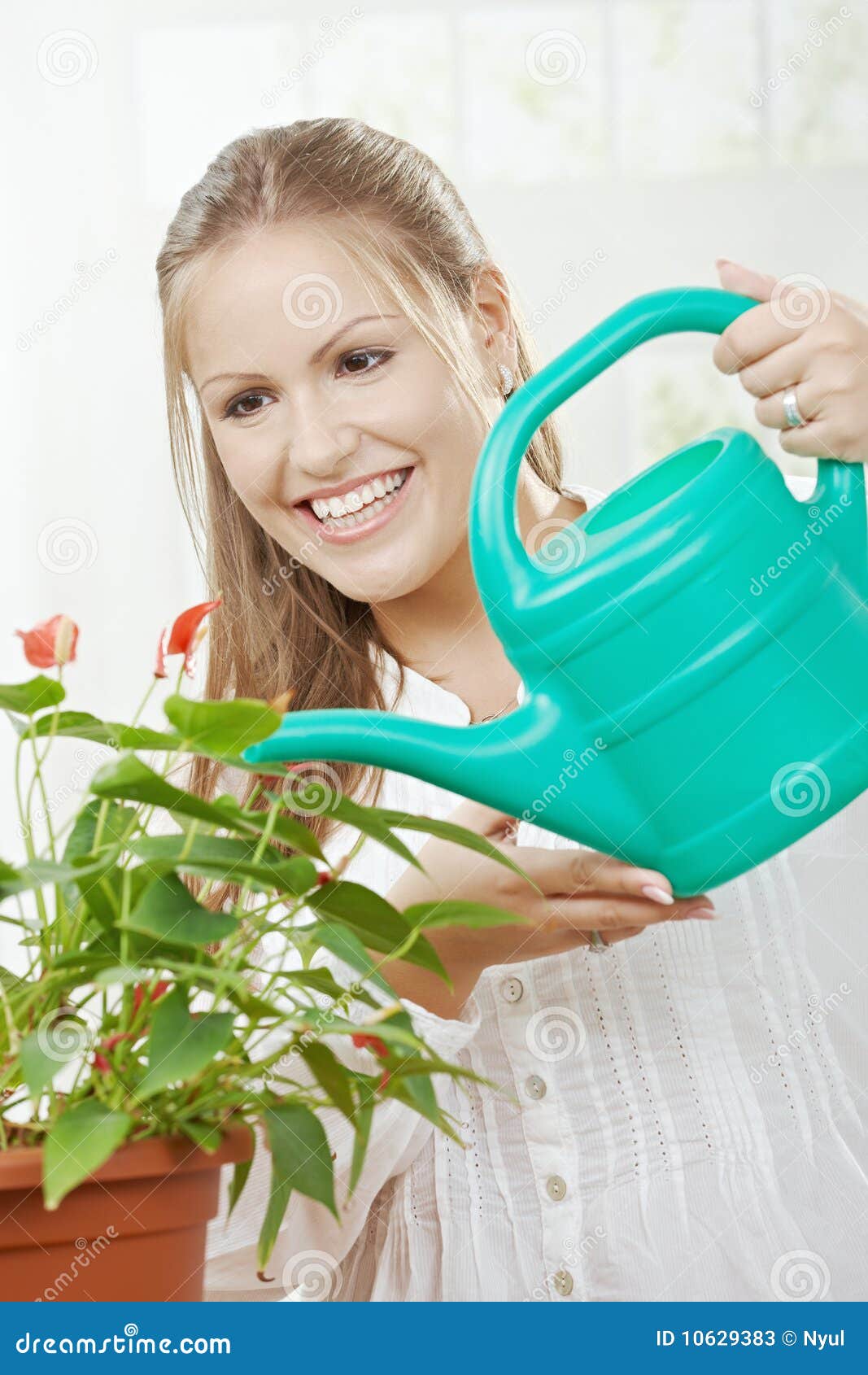 Young woman watering plant stock image. Image of adult - 10629383