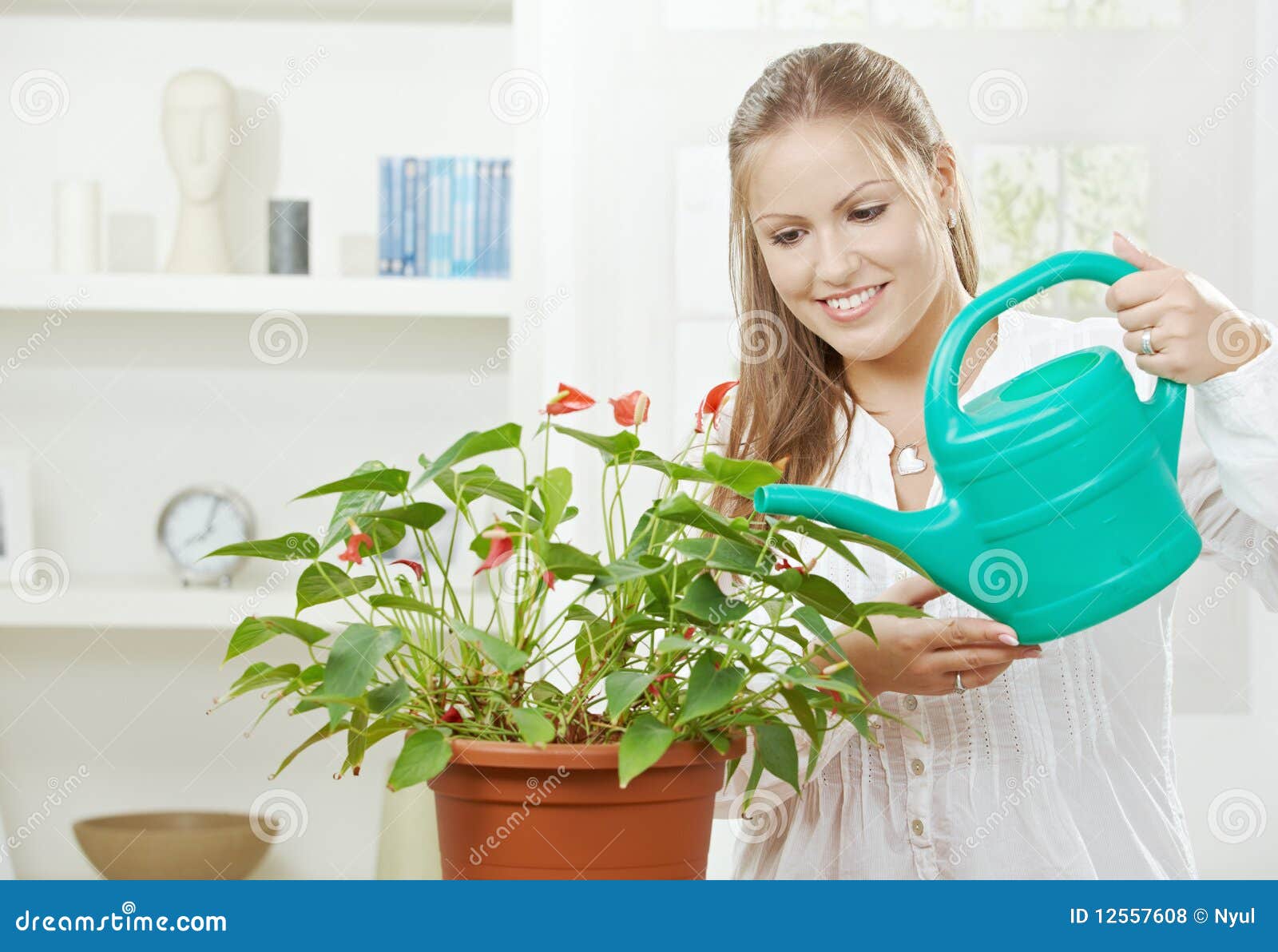 Young woman watering plant stock photo. Image of eyes - 12557608