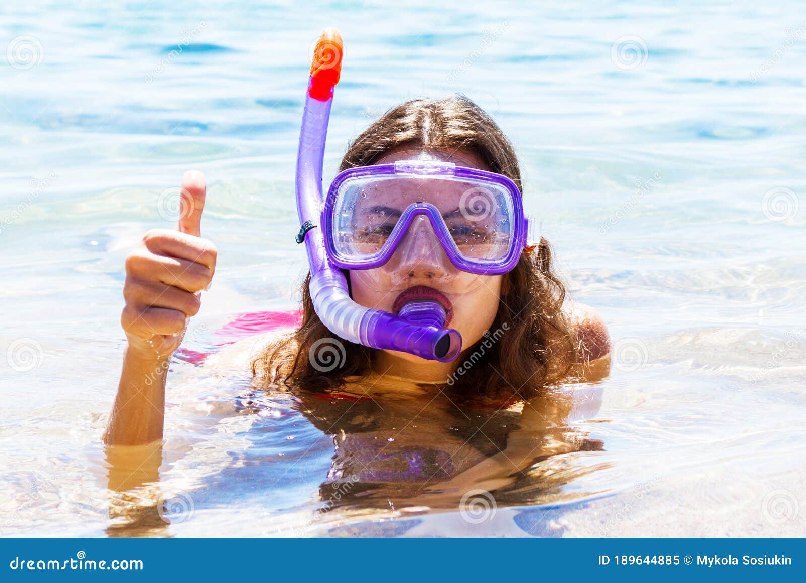 Young Woman Is Wearing Diving Mask And Swimming Tube In The Sea