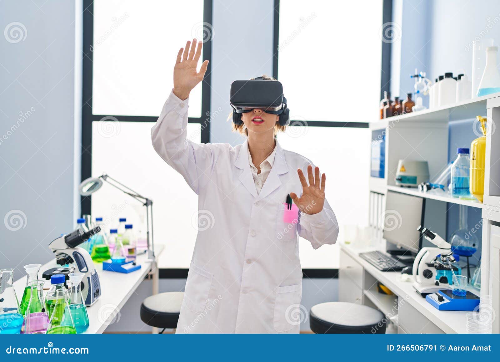 Young Woman Wearing Scientist Uniform Using Virtual Reality Goggles at ...