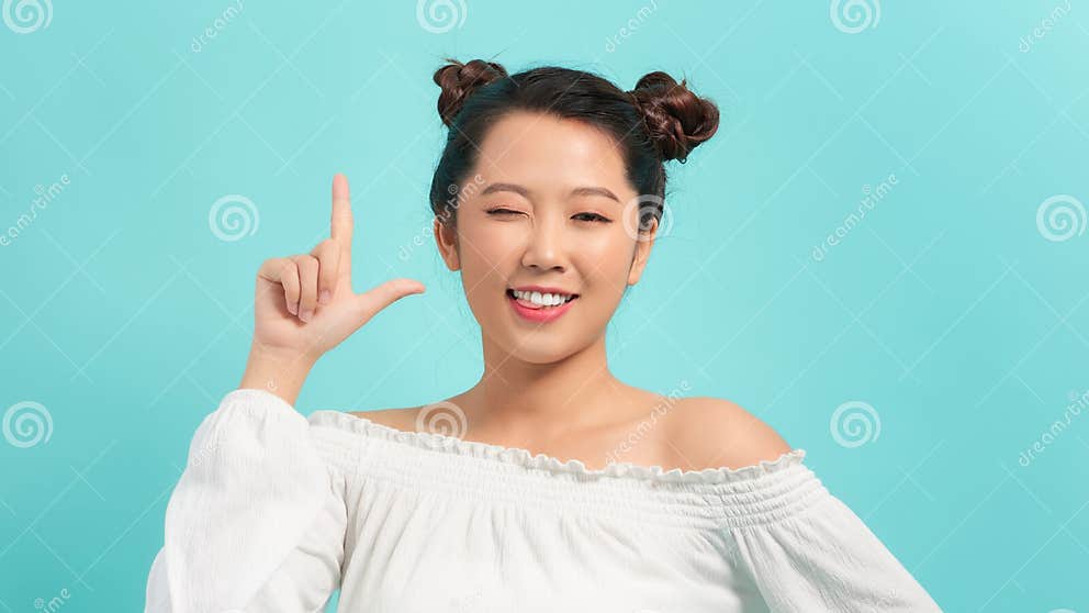 Young Woman Winks and Point at Side Stock Image - Image of winks ...