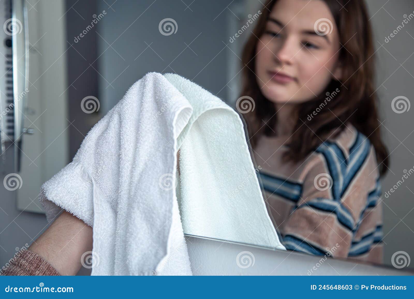 A Young Woman Wipes a Mirror with a Rag. Stock Image - Image of ...