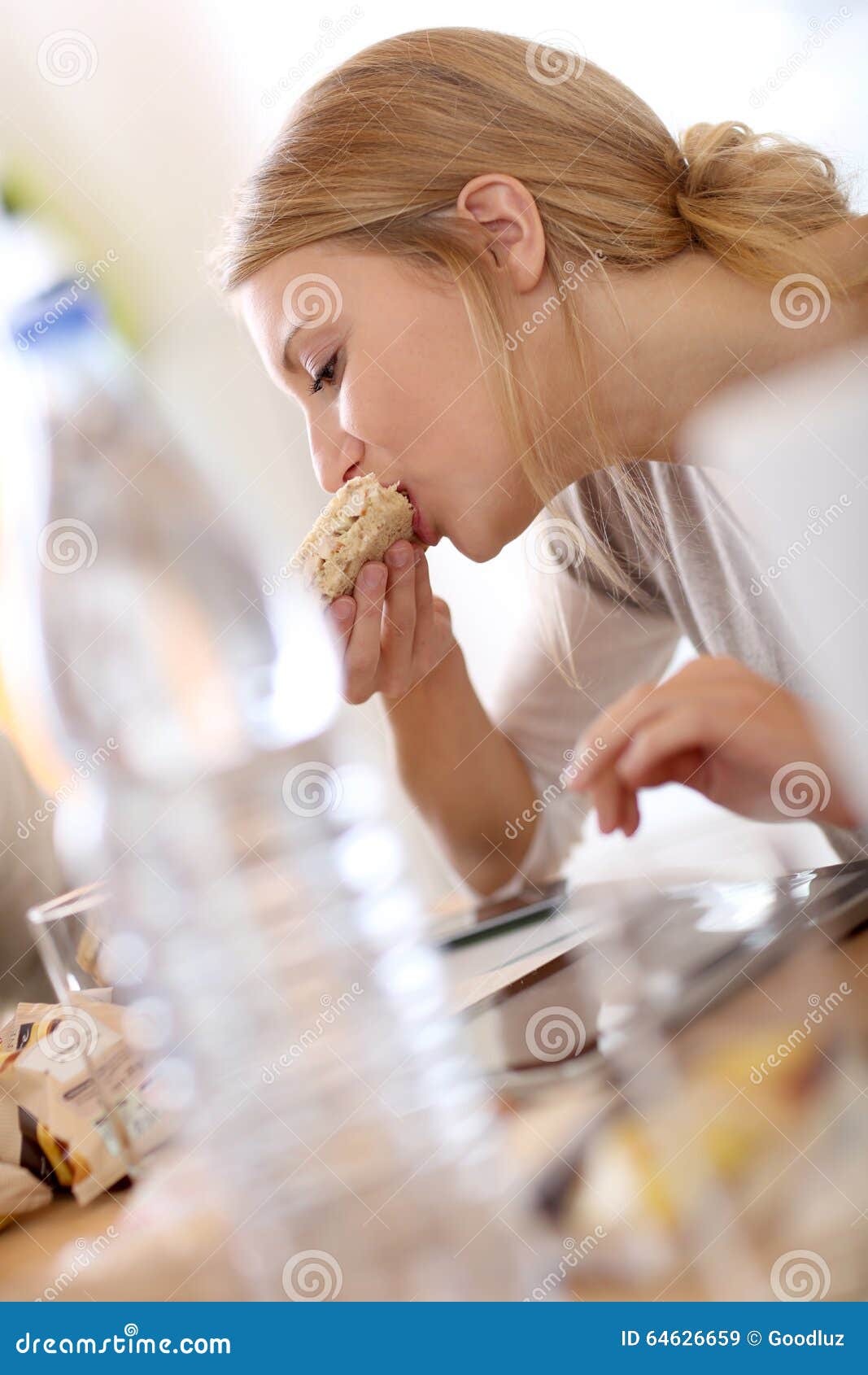 Young Woman at Work Eating Snack and Using Tablet Stock Image - Image ...