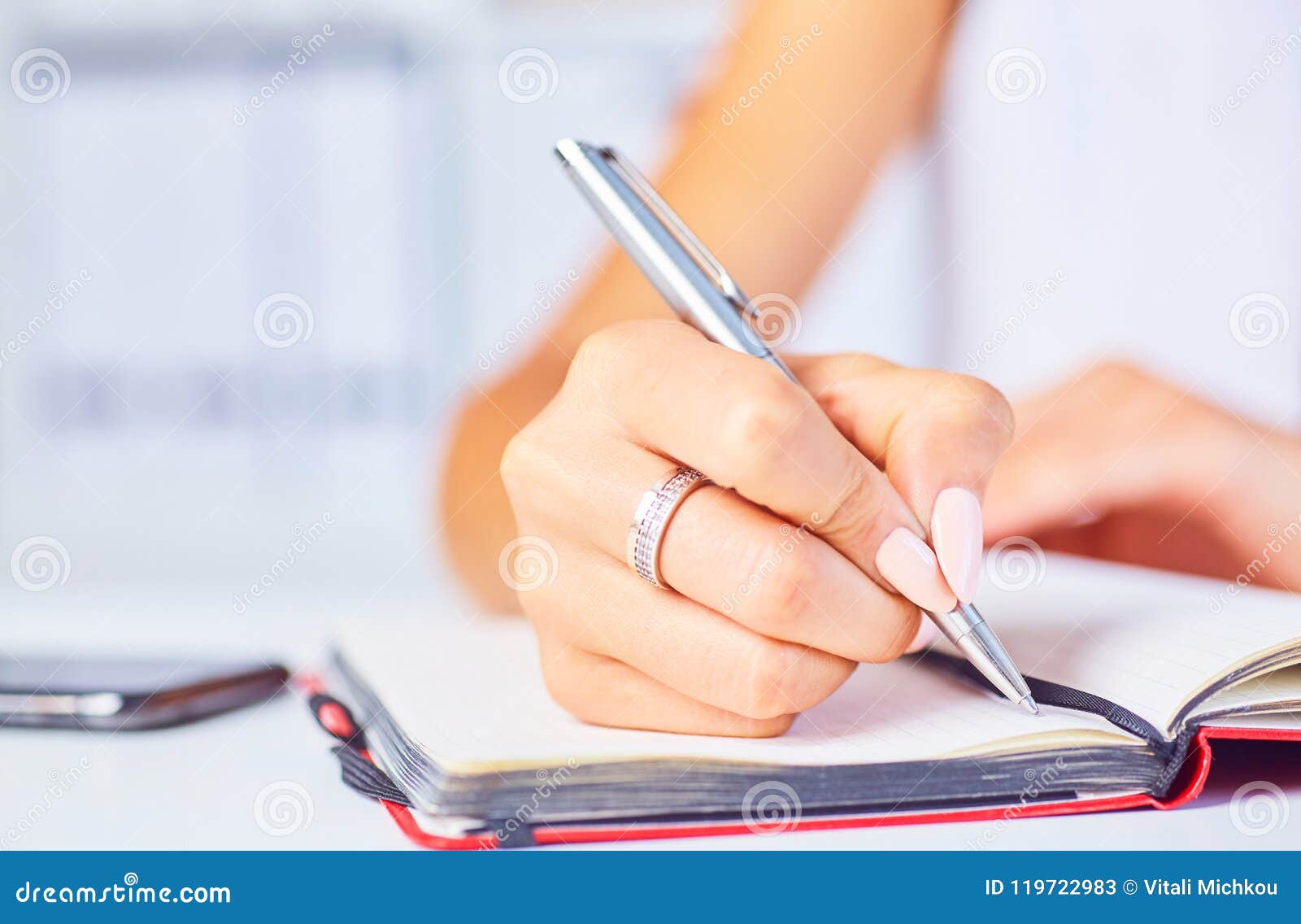 Young Woman Working at Her Desk Taking Notes Closeup. Focus on Hand ...