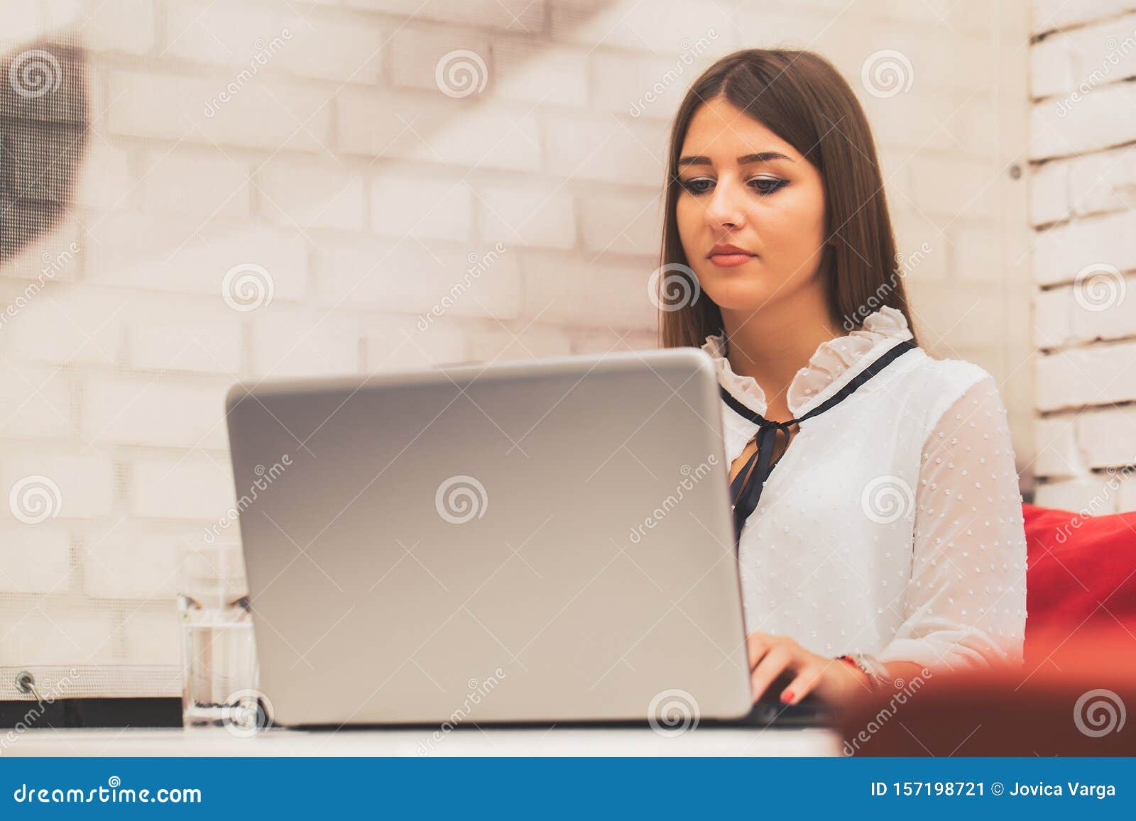 Young Woman Working on a Laptop Computer in a Coffee Shop Stock Image ...