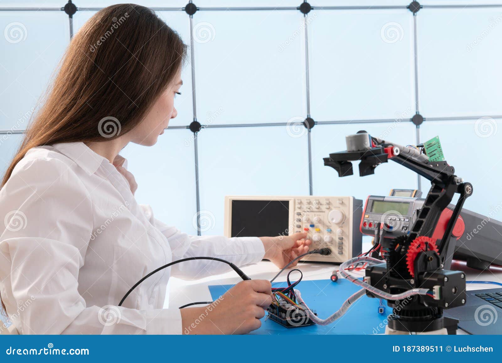 A Young Woman Writes an Algorithm for the Robot Arm. Science Research ...