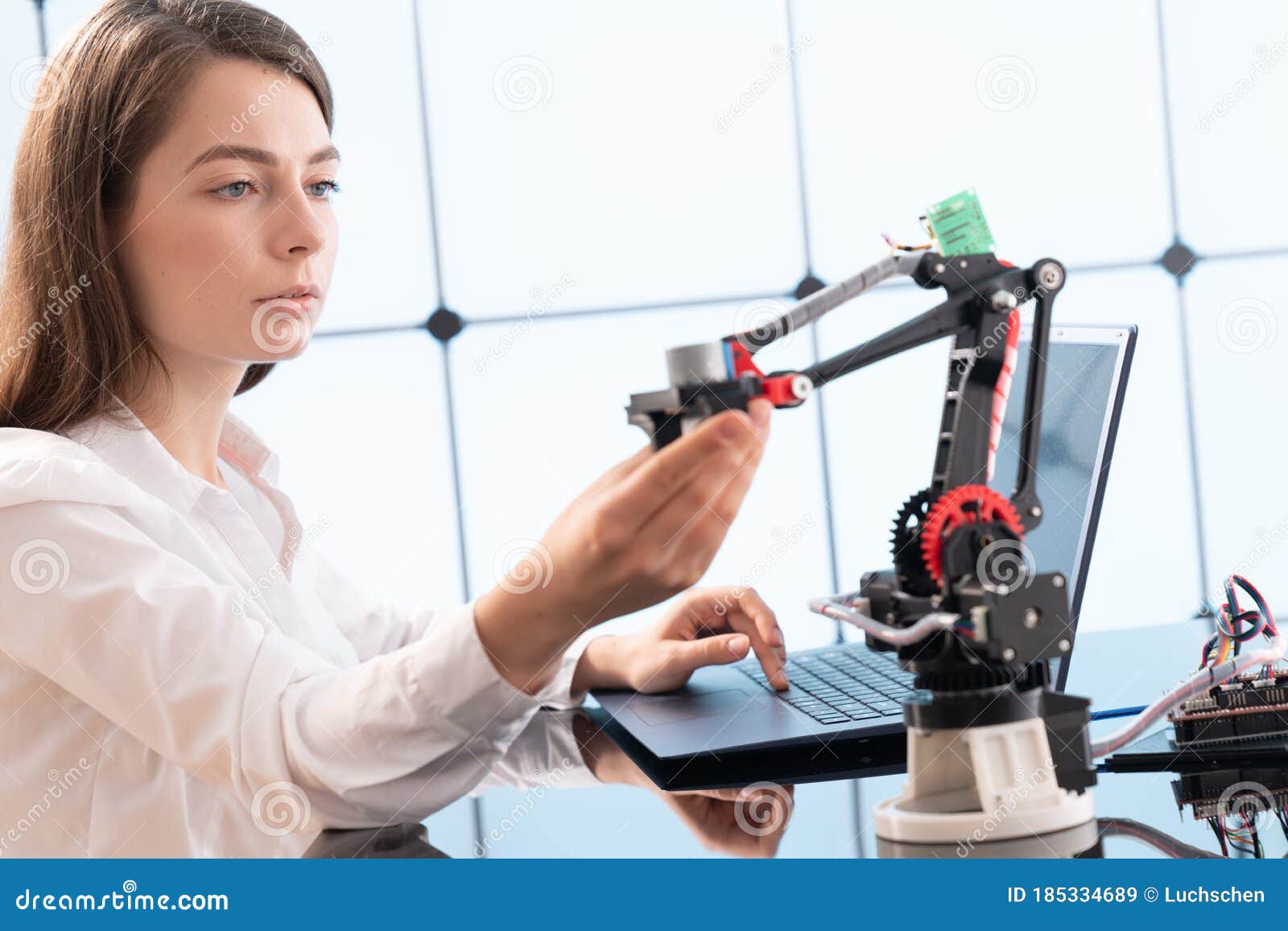 A Young Woman Writes an Algorithm for the Robot Arm. Science Research ...