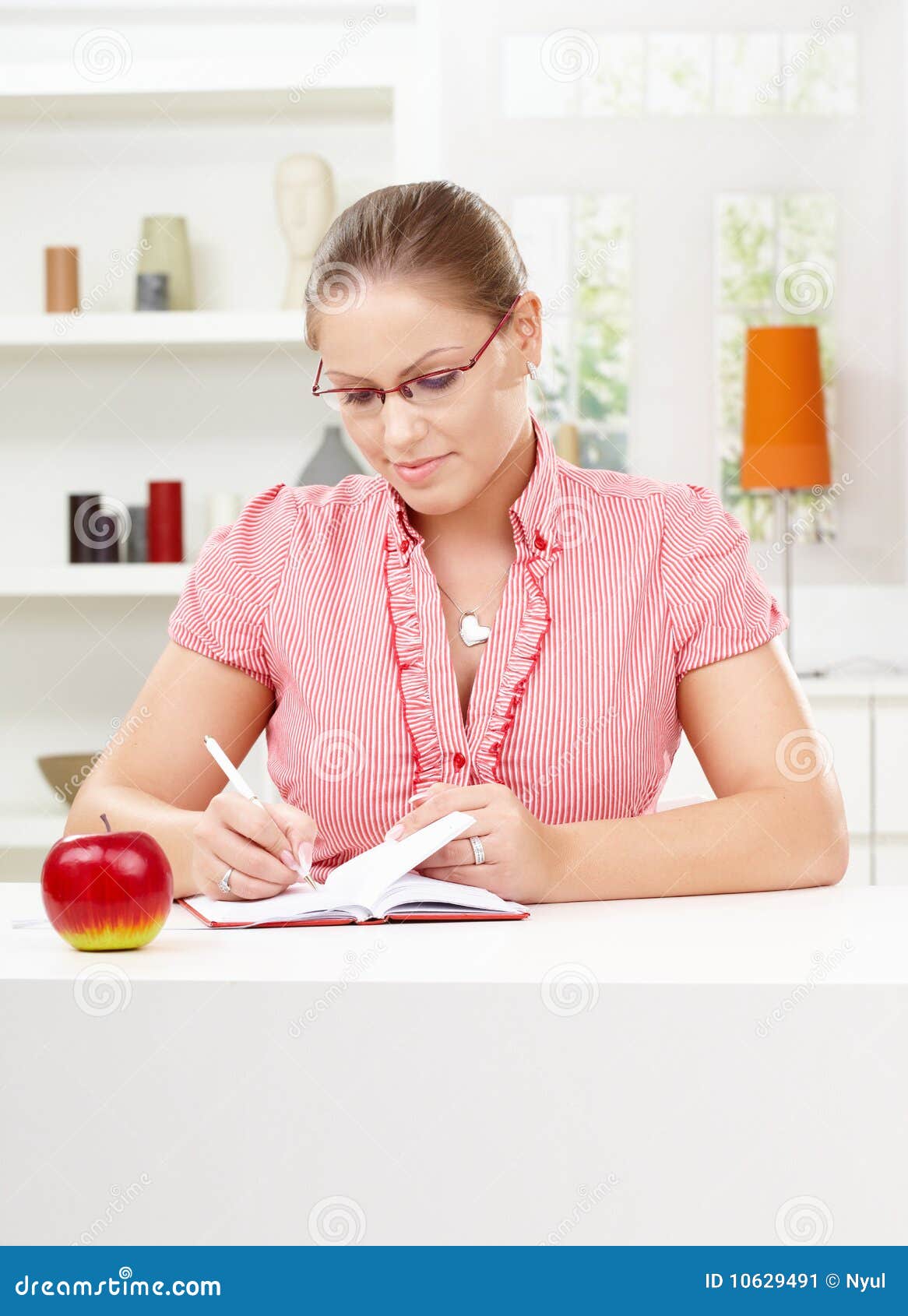 Young woman writing diary stock image. Image of indoors - 10629491