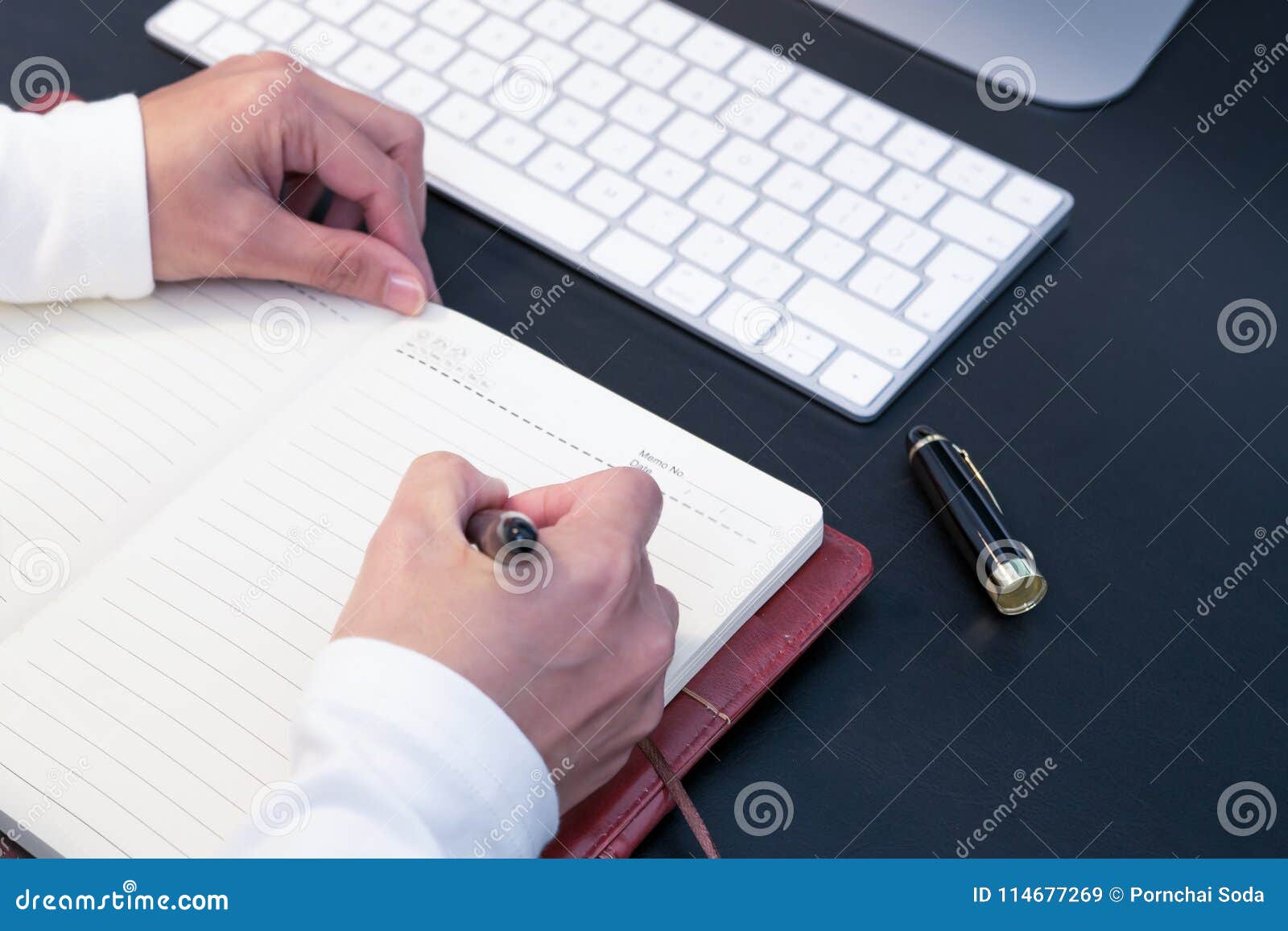 Young Woman Writing in Notebook on Desktop Computer and Keyboard Placed ...