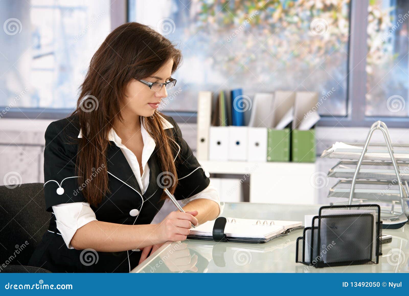 Young woman writing notes stock photo. Image of looking - 13492050