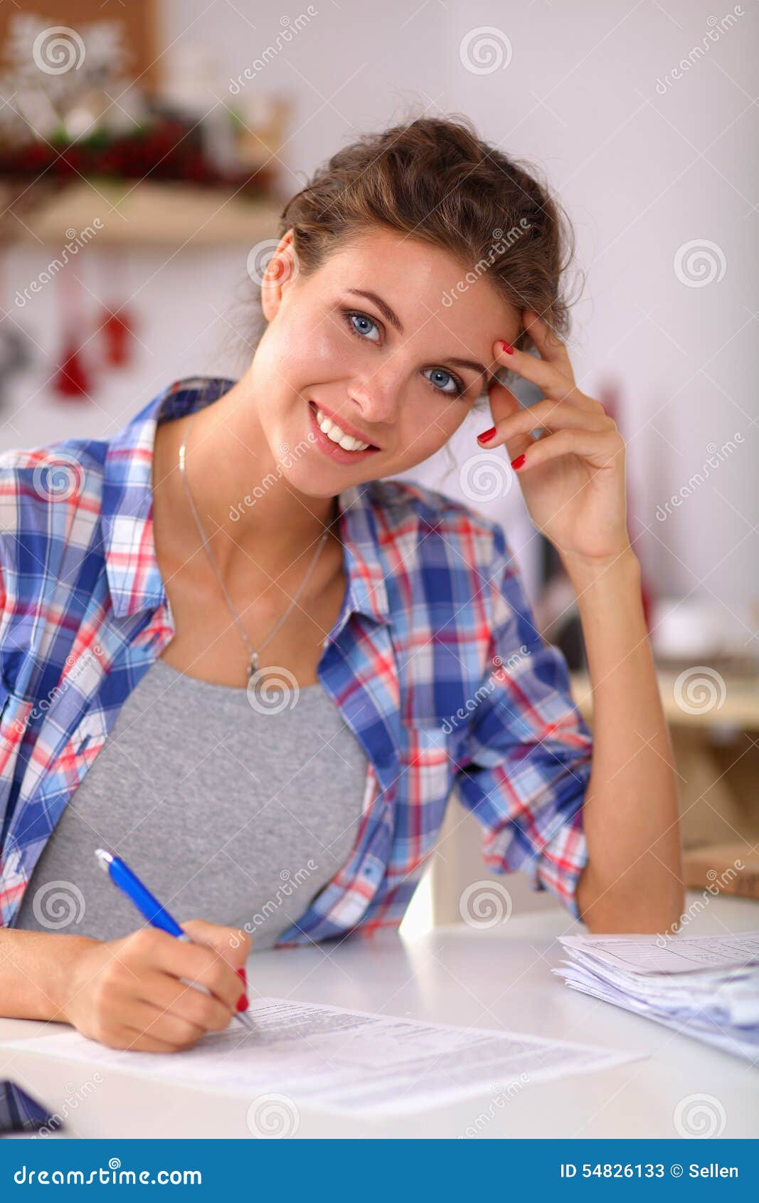 Young Woman Writing Something in Her Note Pad Stock Image - Image of ...