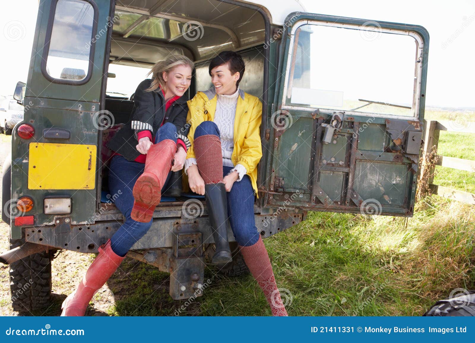 Young Women in the Country Putting on Boots Stock Image - Image of road ...