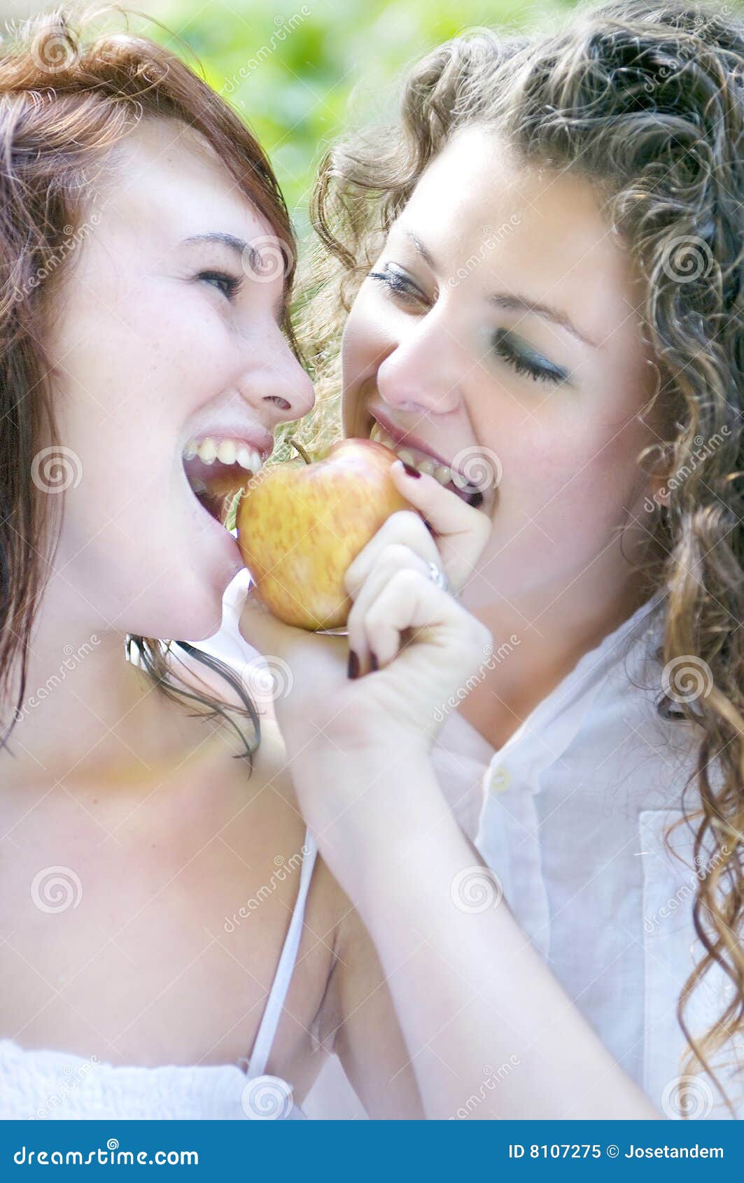 Young Women Eating an Apple and Laughing Stock Image - Image of ...