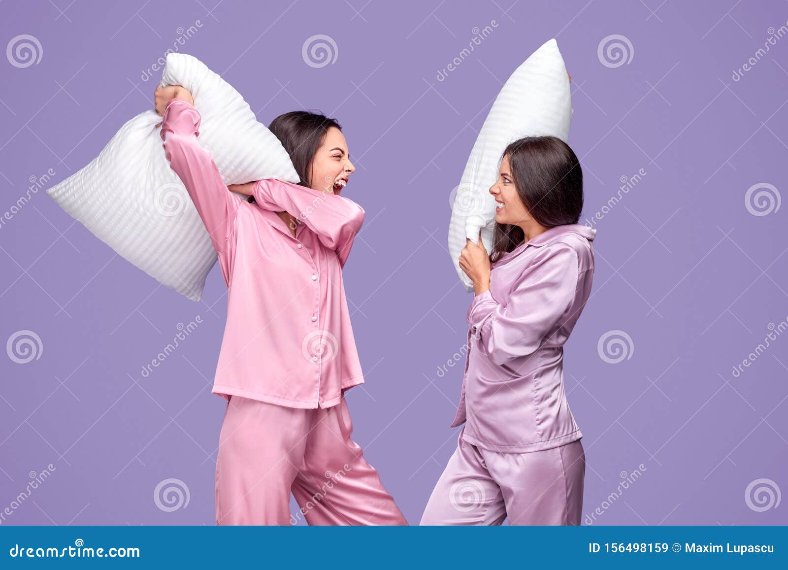 Young Women Having Pillow Fight During Sleepover Stock Image Image Of