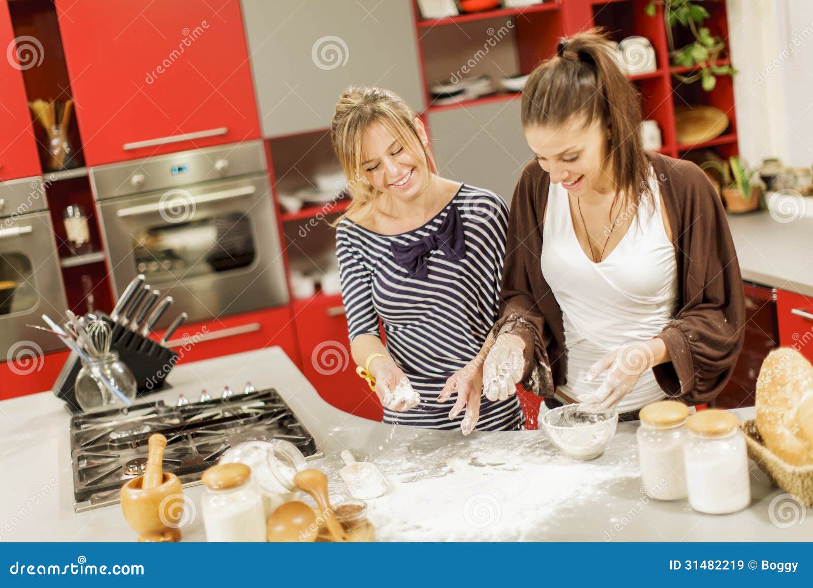 Young women in the kitchen stock image. Image of dinner - 31482219