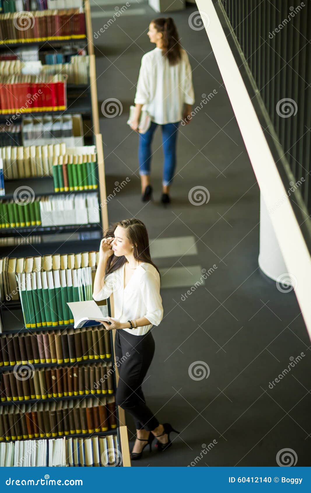 Young women in the library stock photo. Image of standing - 60412140