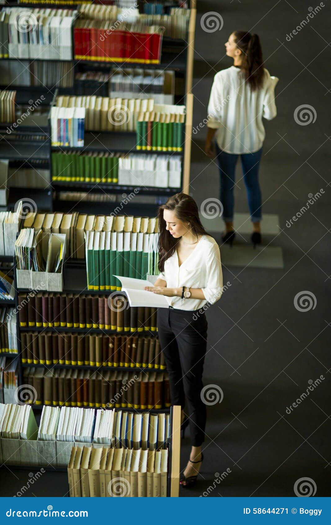 Young women in the library stock image. Image of student - 58644271