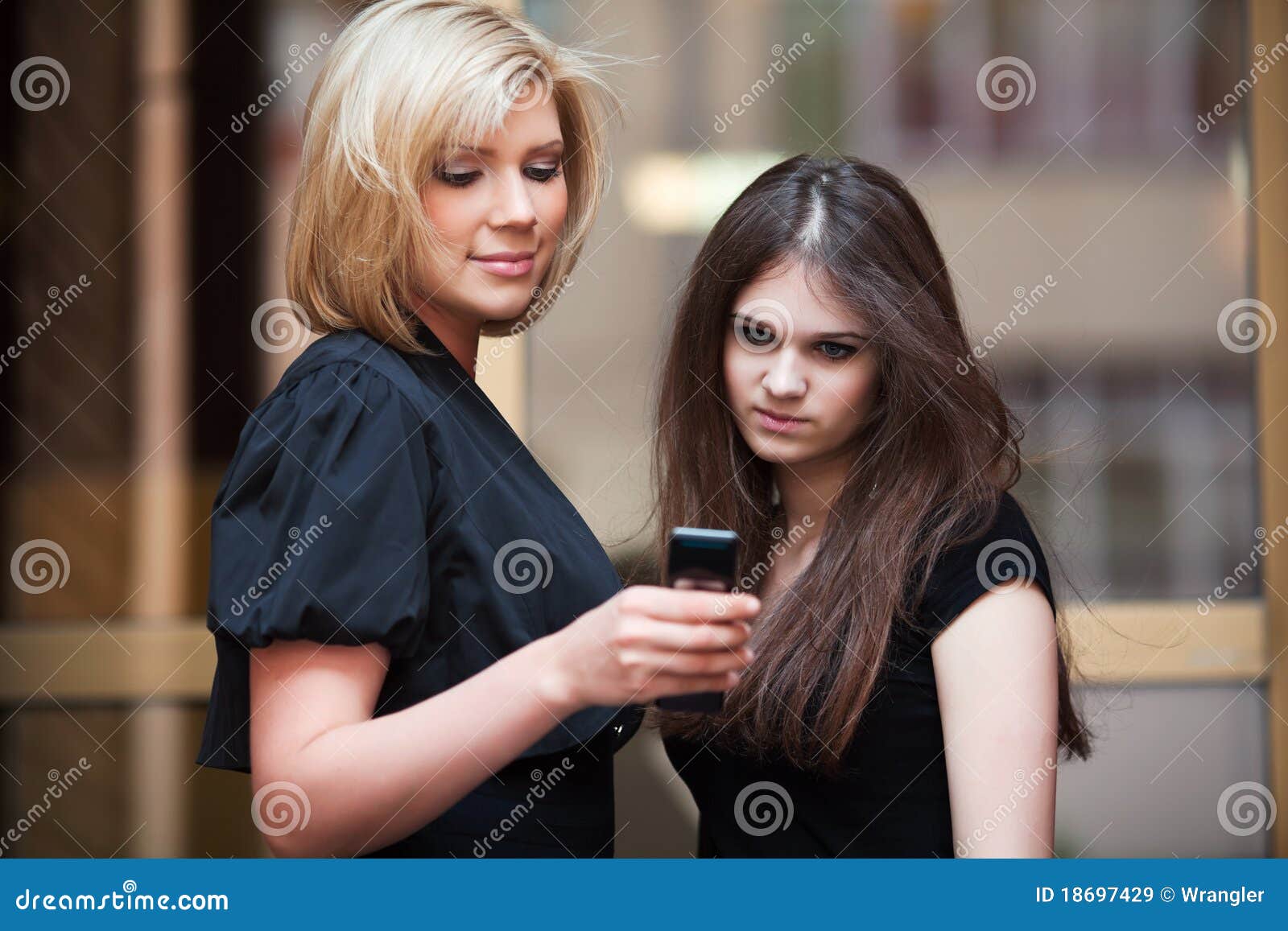Young Women Looking at Mobile Phone Stock Image - Image of education ...