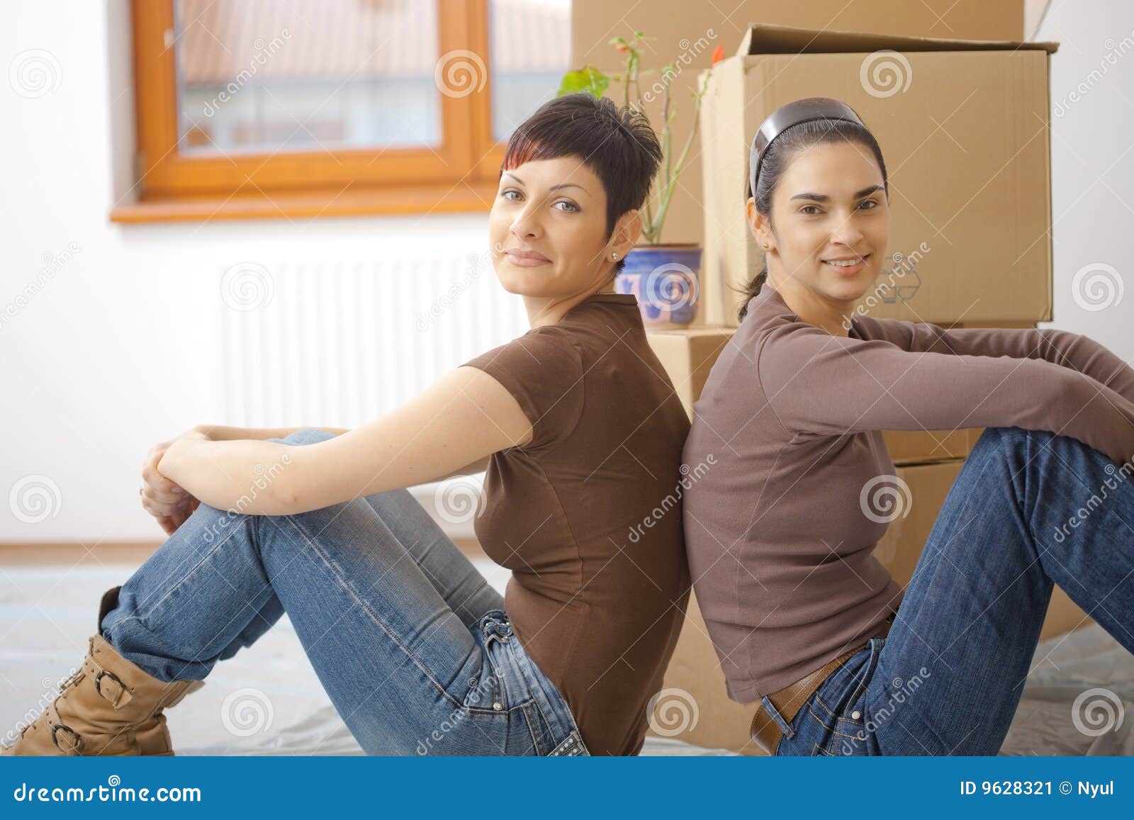 Young women moving home stock image. Image of cheerful - 9628321