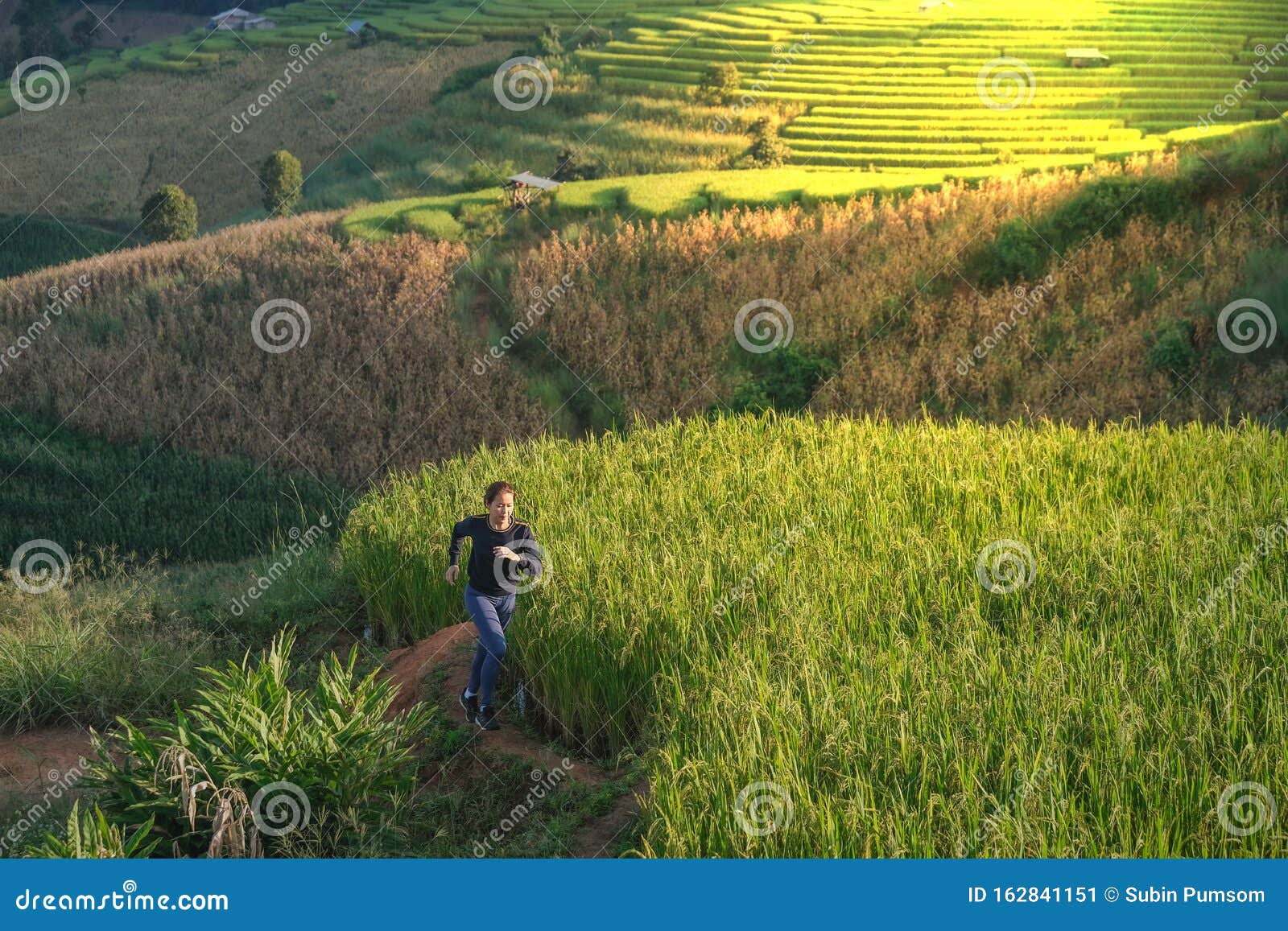 Young Women Run and Run in Fields with Mountains and Sunsets Stock ...
