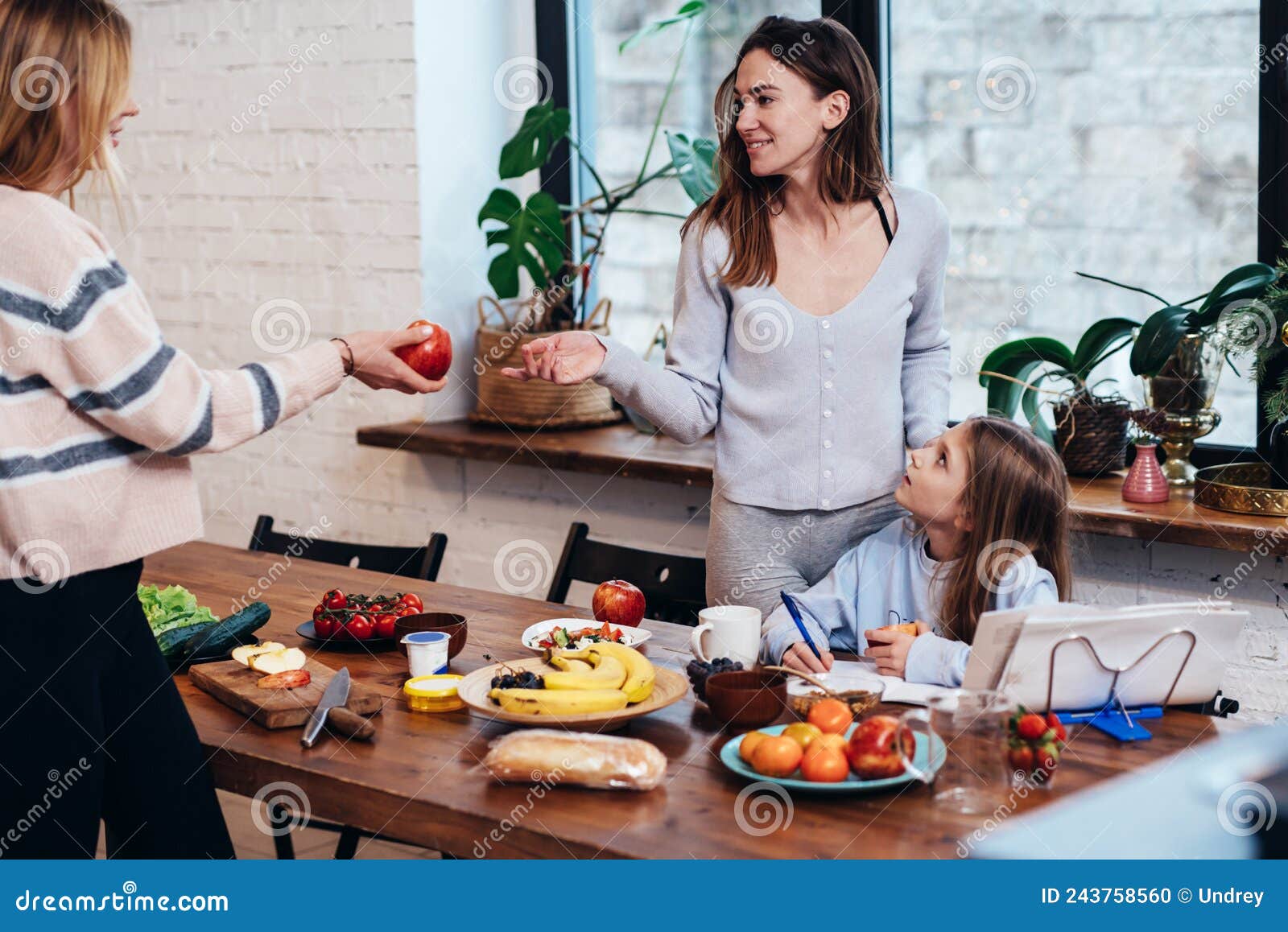 Young Women Set the Table, Girl Does Her Homework Stock Photo - Image ...