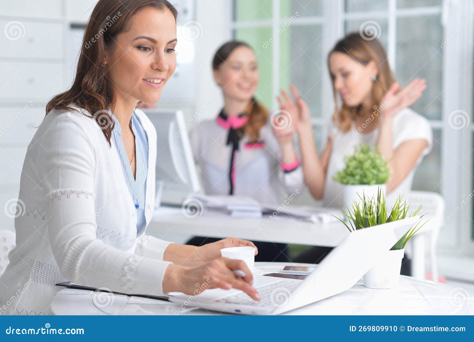 Young Women Sit at the Table and Work in a Modern Office Stock Photo ...