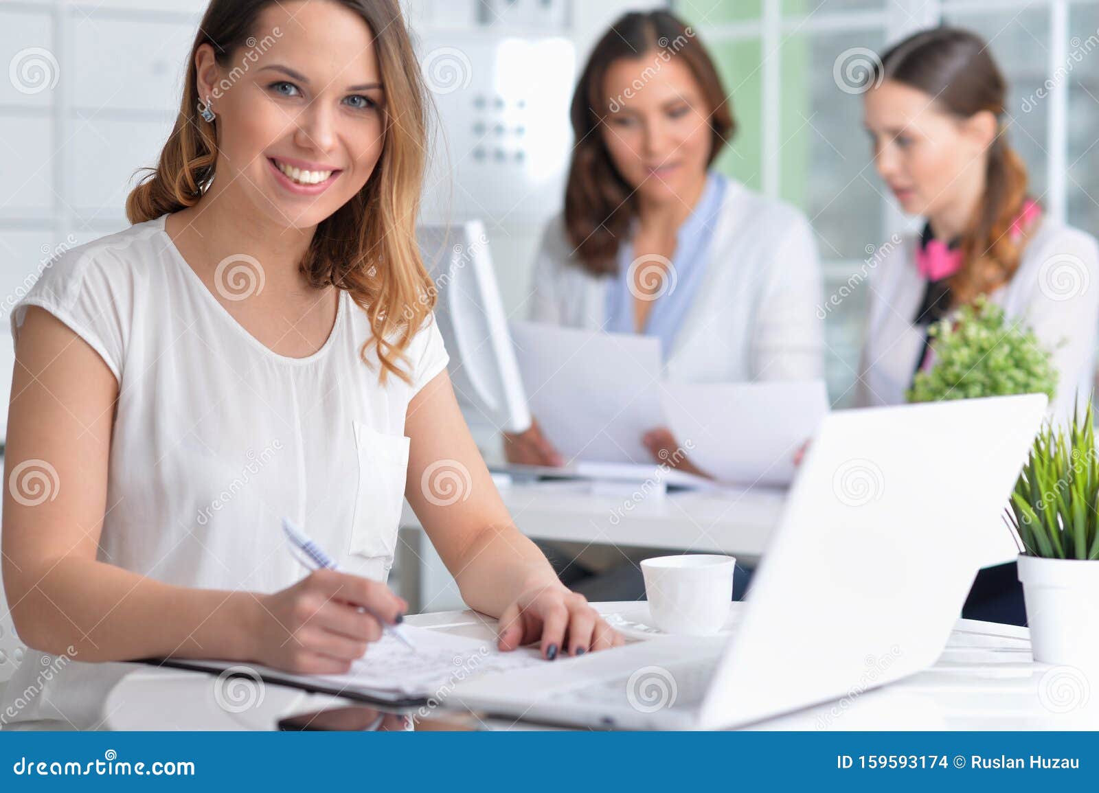 Young Women Sit at the Table and Work in a Modern Office Stock Photo ...