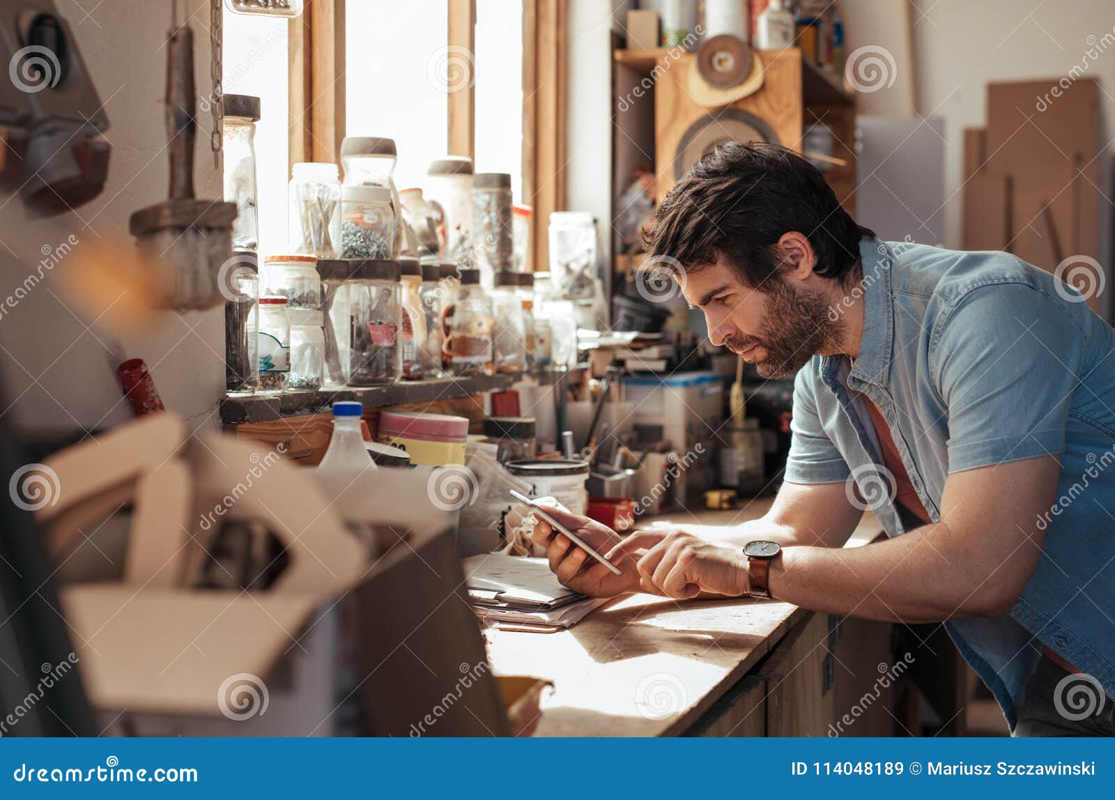 Young Woodworker Using a Tablet in His Workshop Stock Image - Image of ...