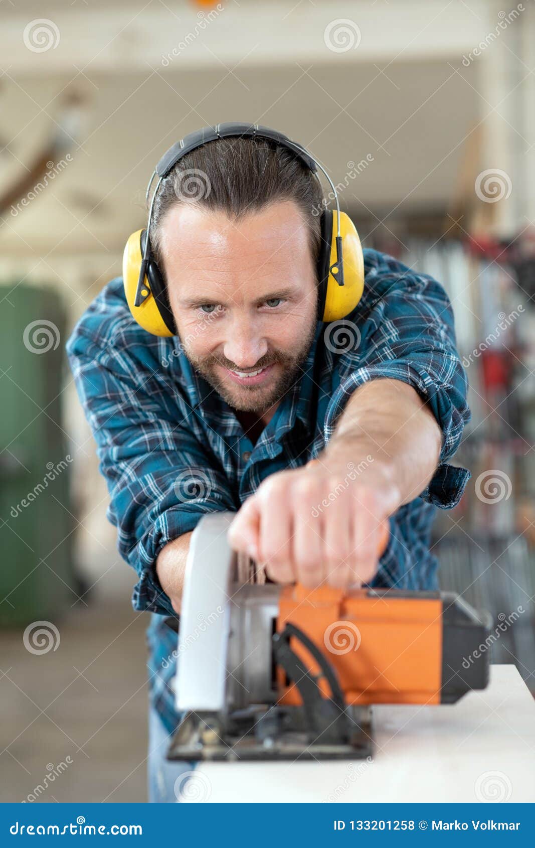 Young Worker in a Carpenter`s Workshop with Hand Saw Stock Photo ...